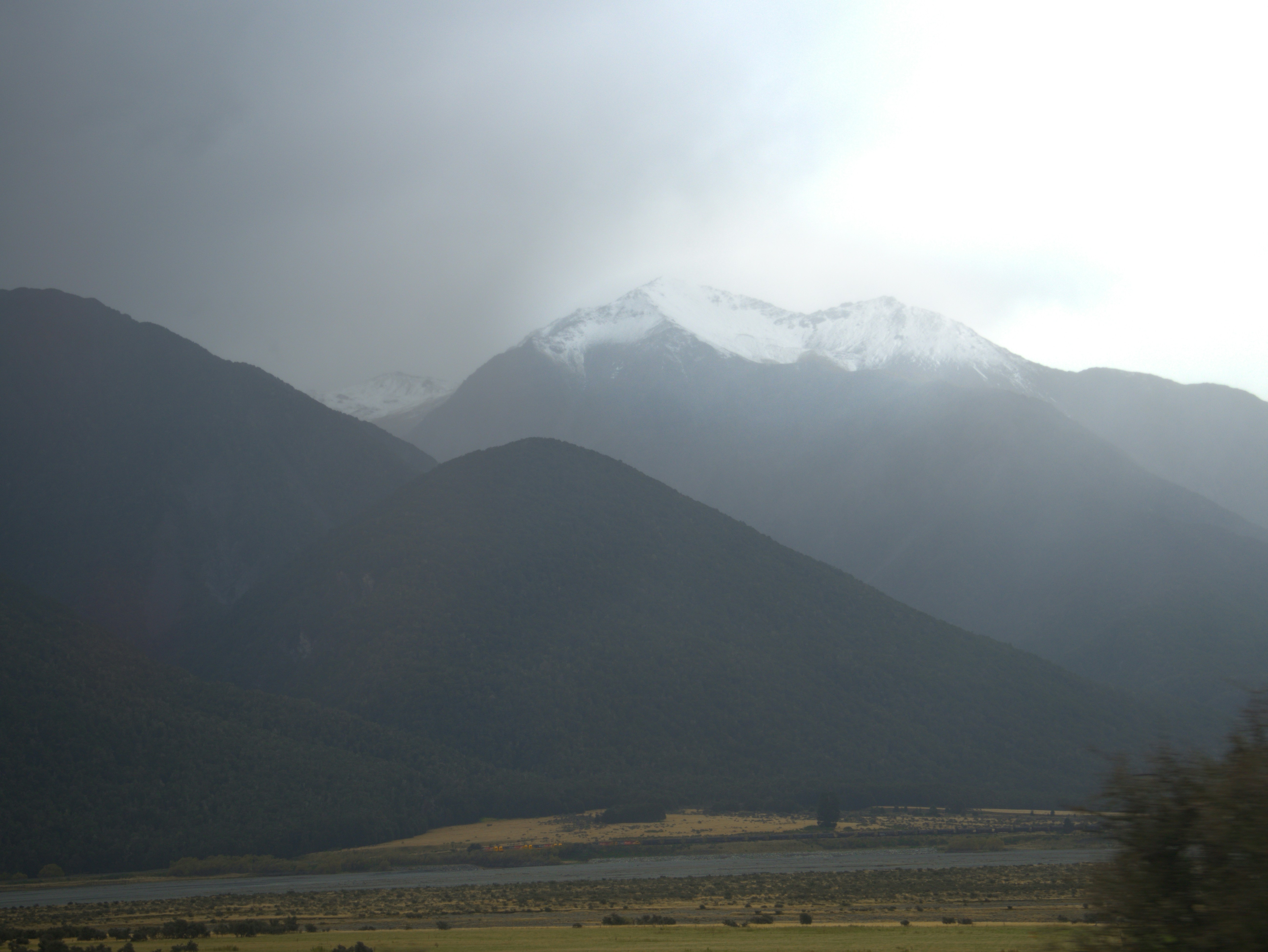 Misty Valleys beneath a Snow-Capped Peak