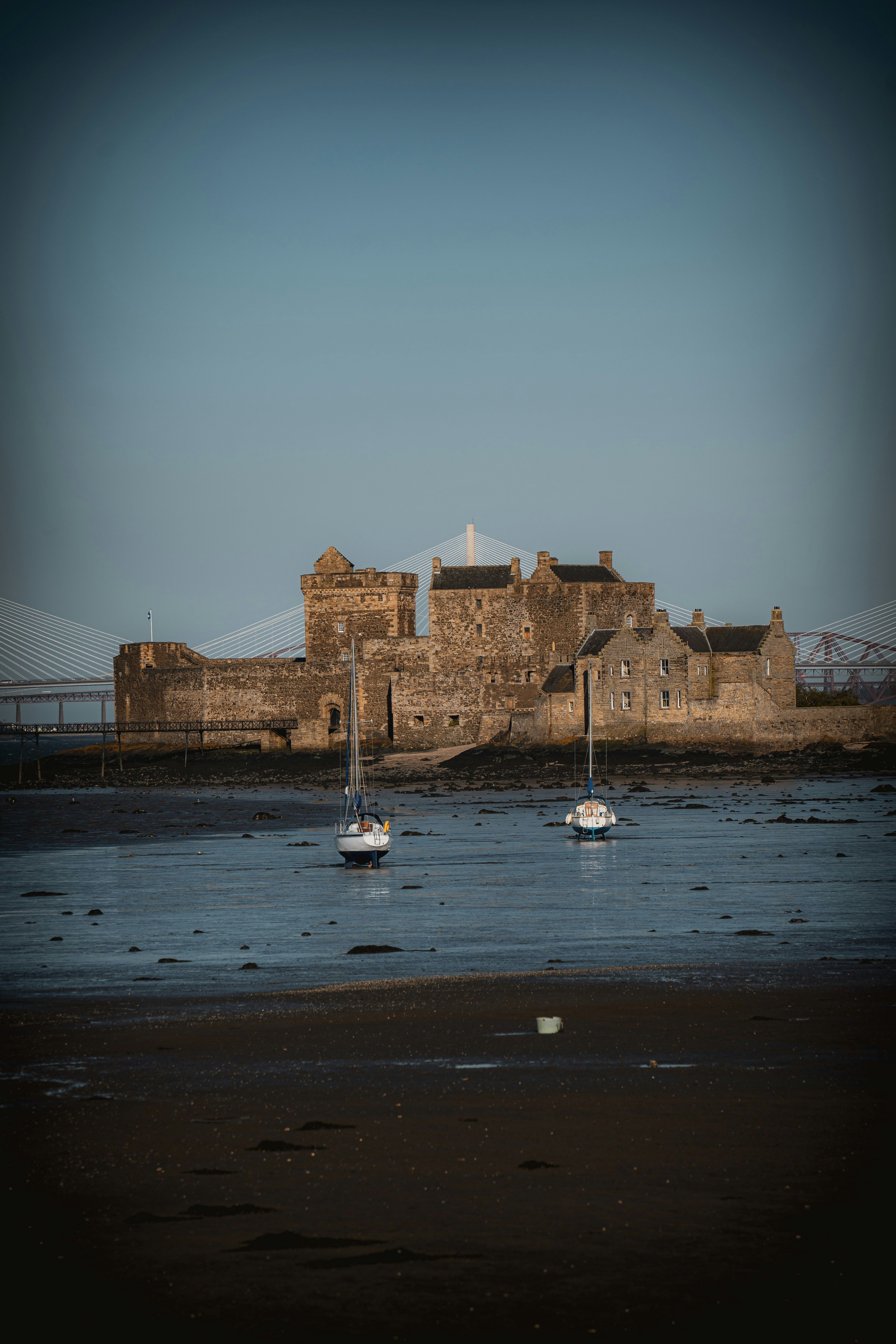 Fortress by the Tide: Boats at Low Water Beneath a Quiet Sky