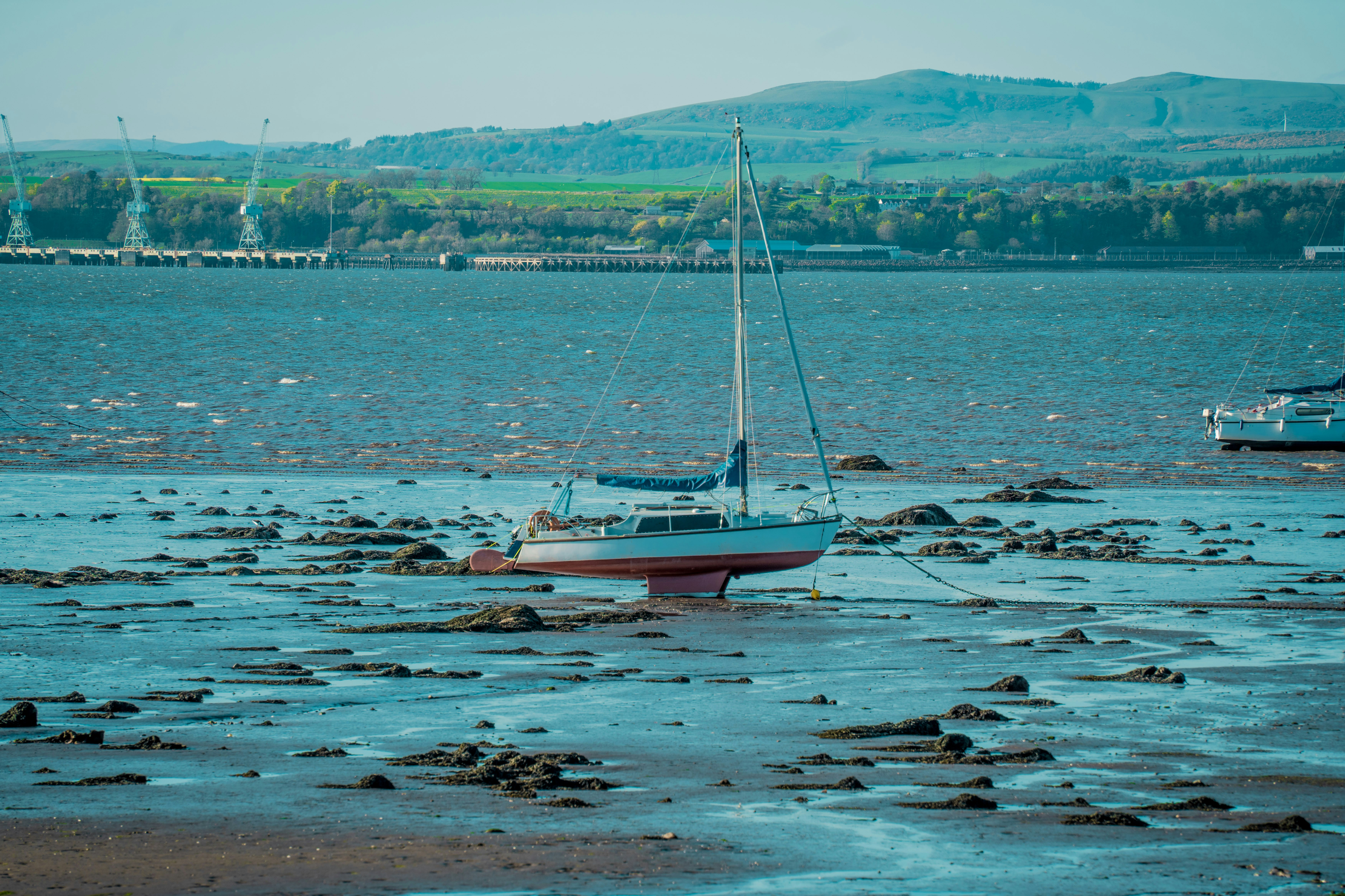 Sailboat Resting Between Tidal Blues