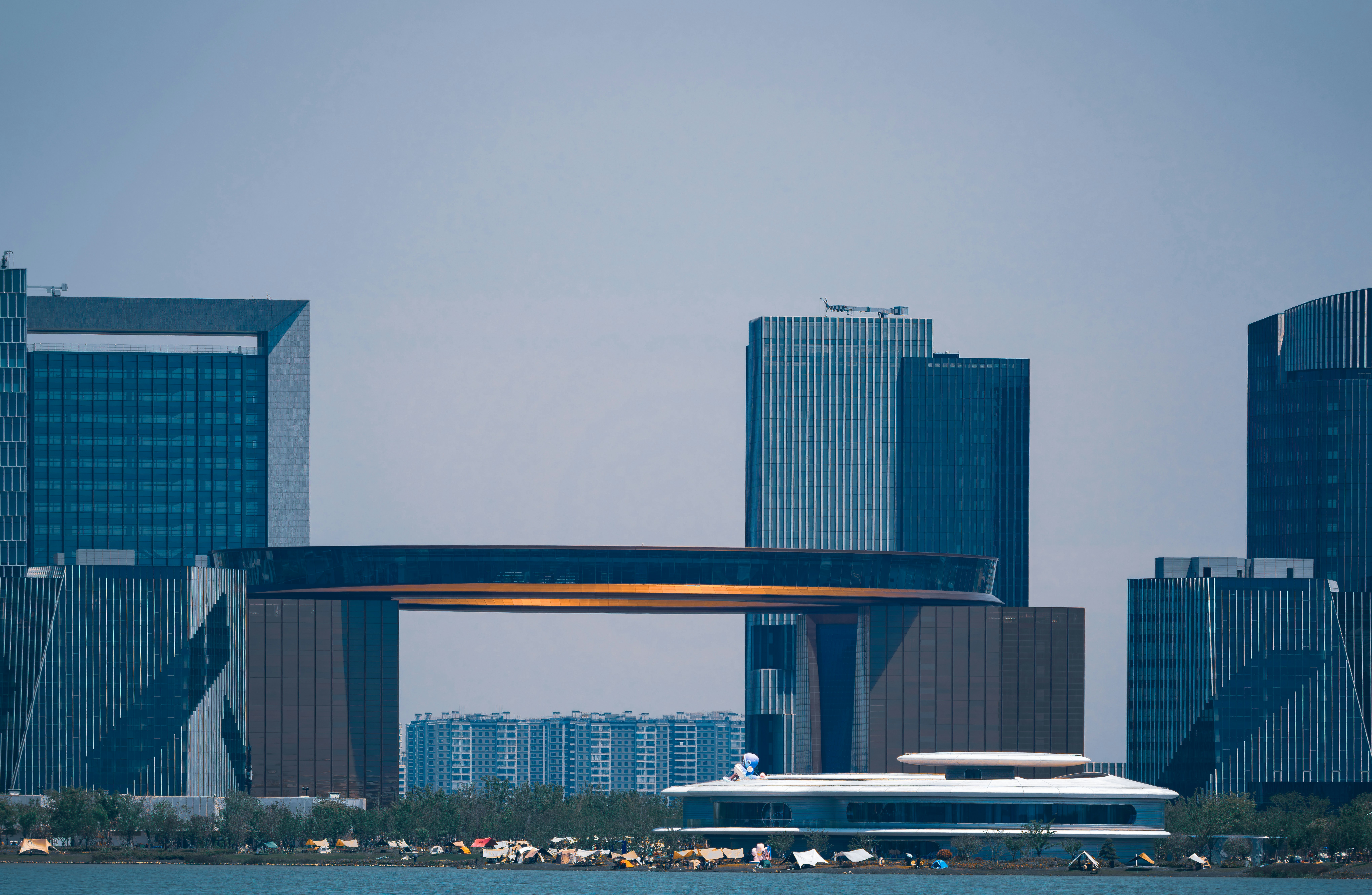 Harbor Silhouette: A Sleek Waterfront Transit Framing a Modern Skyline
