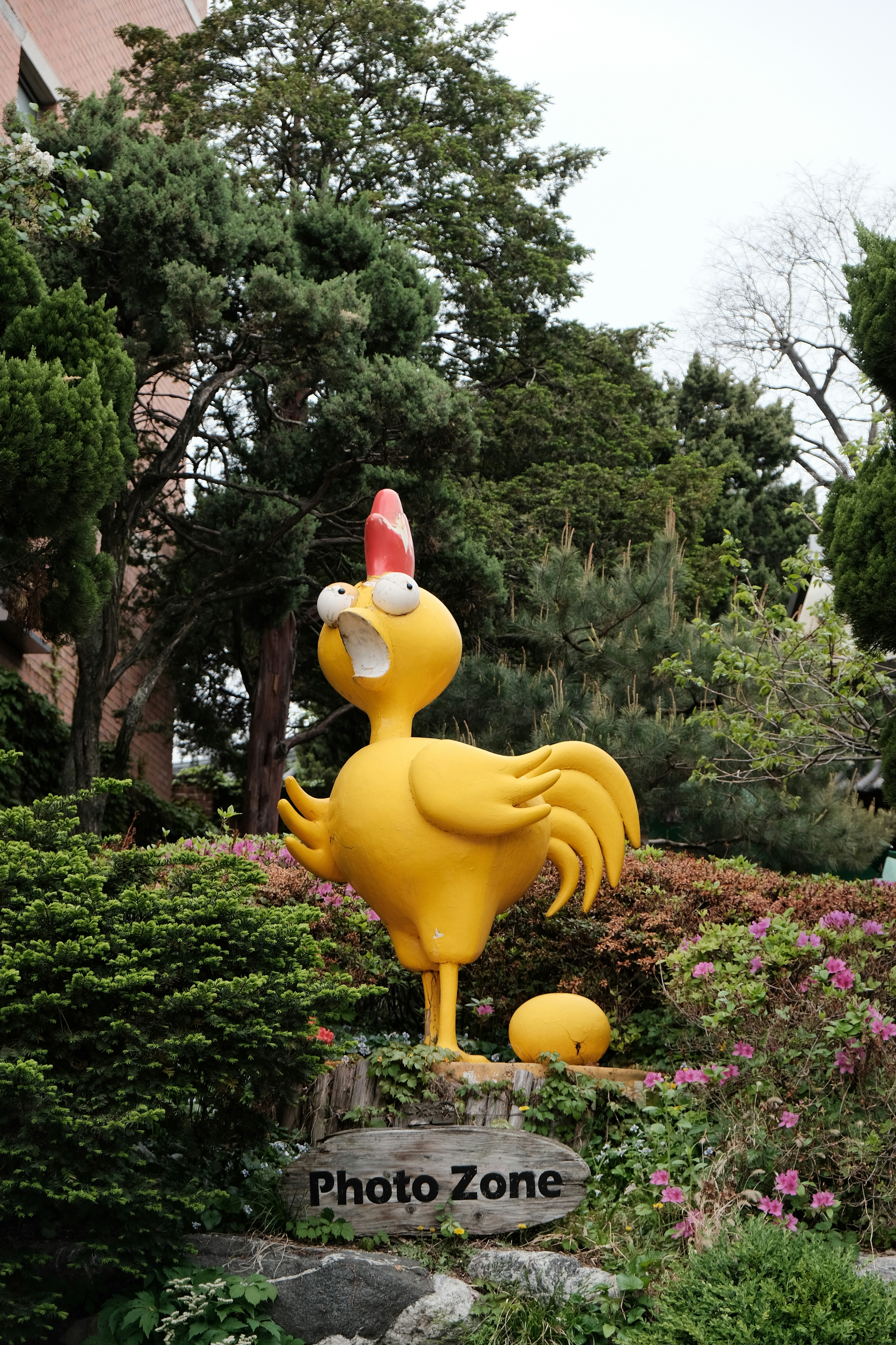 Yellow Chicken statue in a themed garden zone