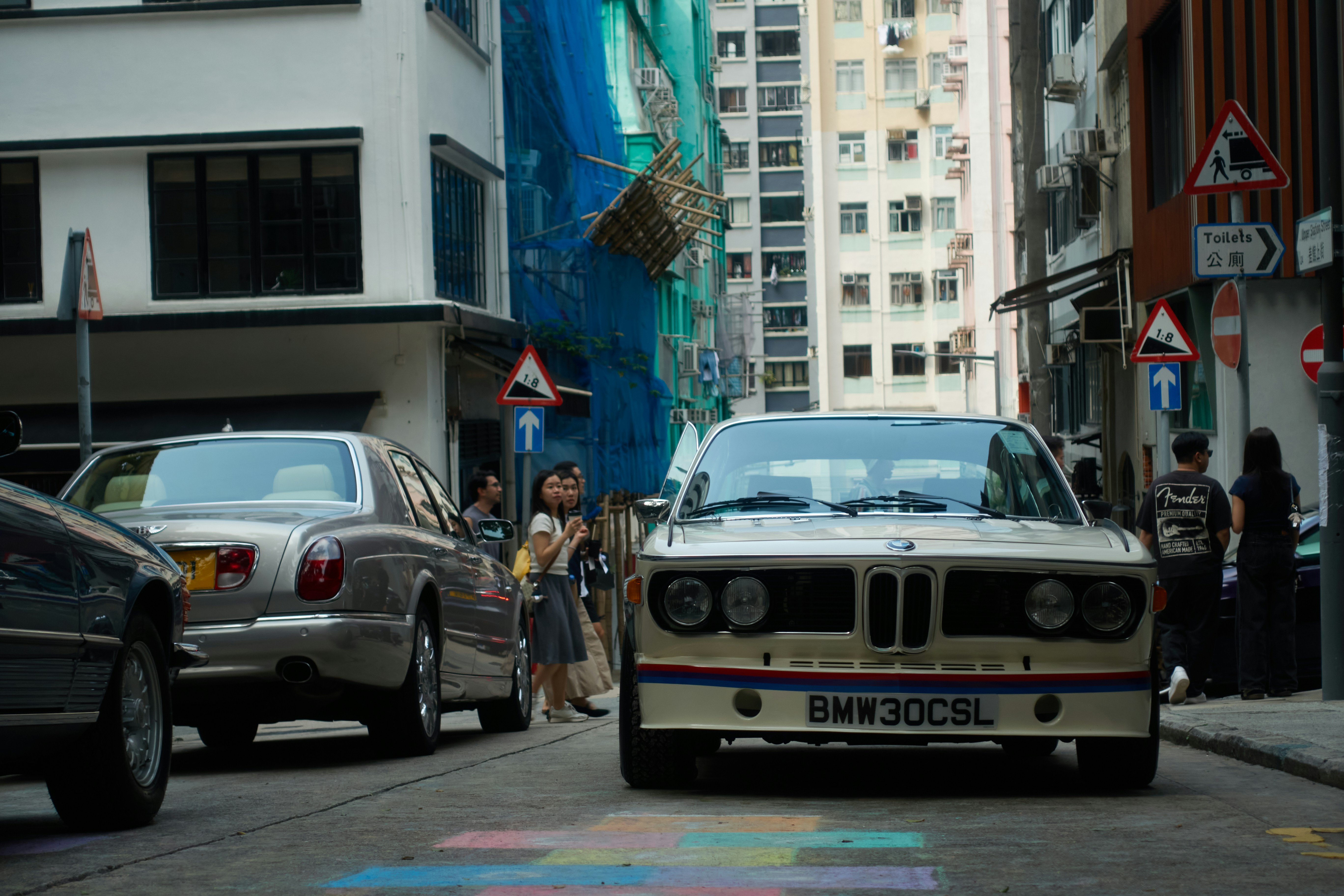 Front-and-Crowd: A Classic Car in a Bustling Urban Street