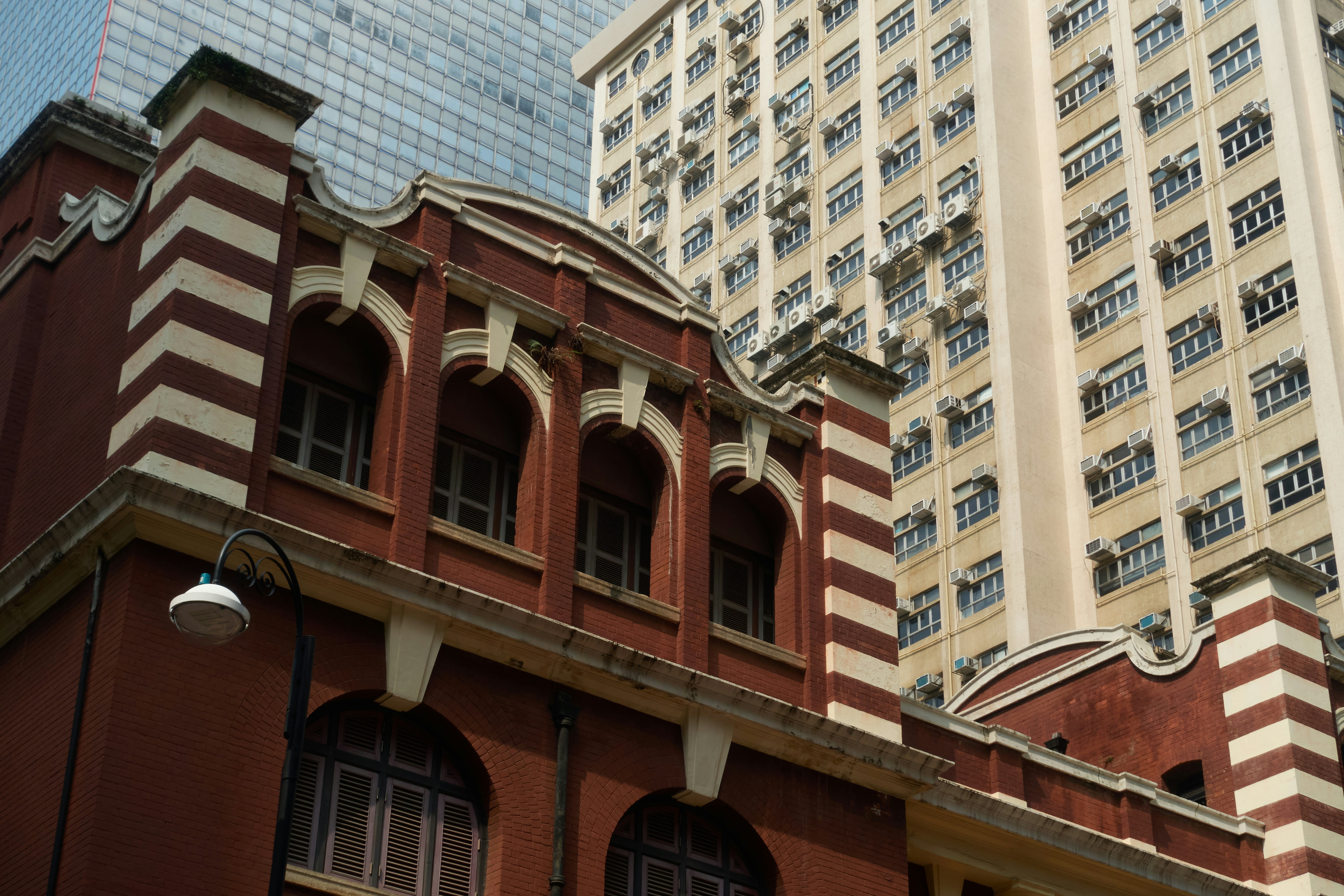 Brick Facade Beneath Tall Windows with Urban Skyline