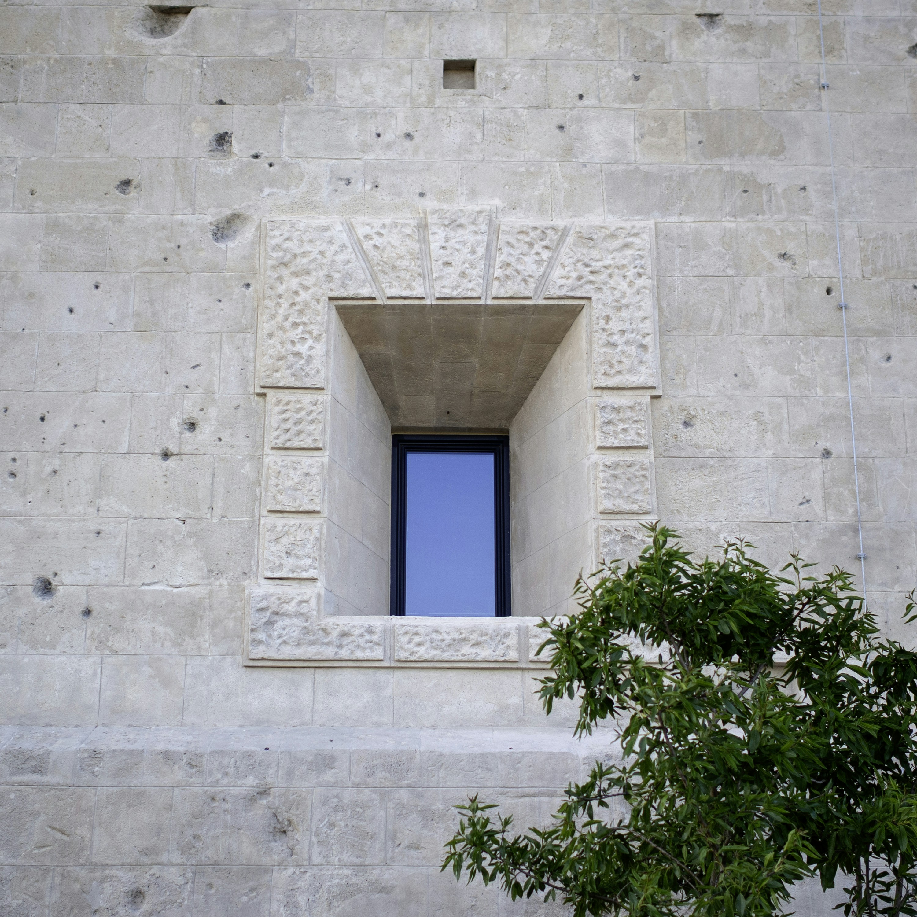 Stone Window Frame with Greenery: A Quiet Architectural Moment