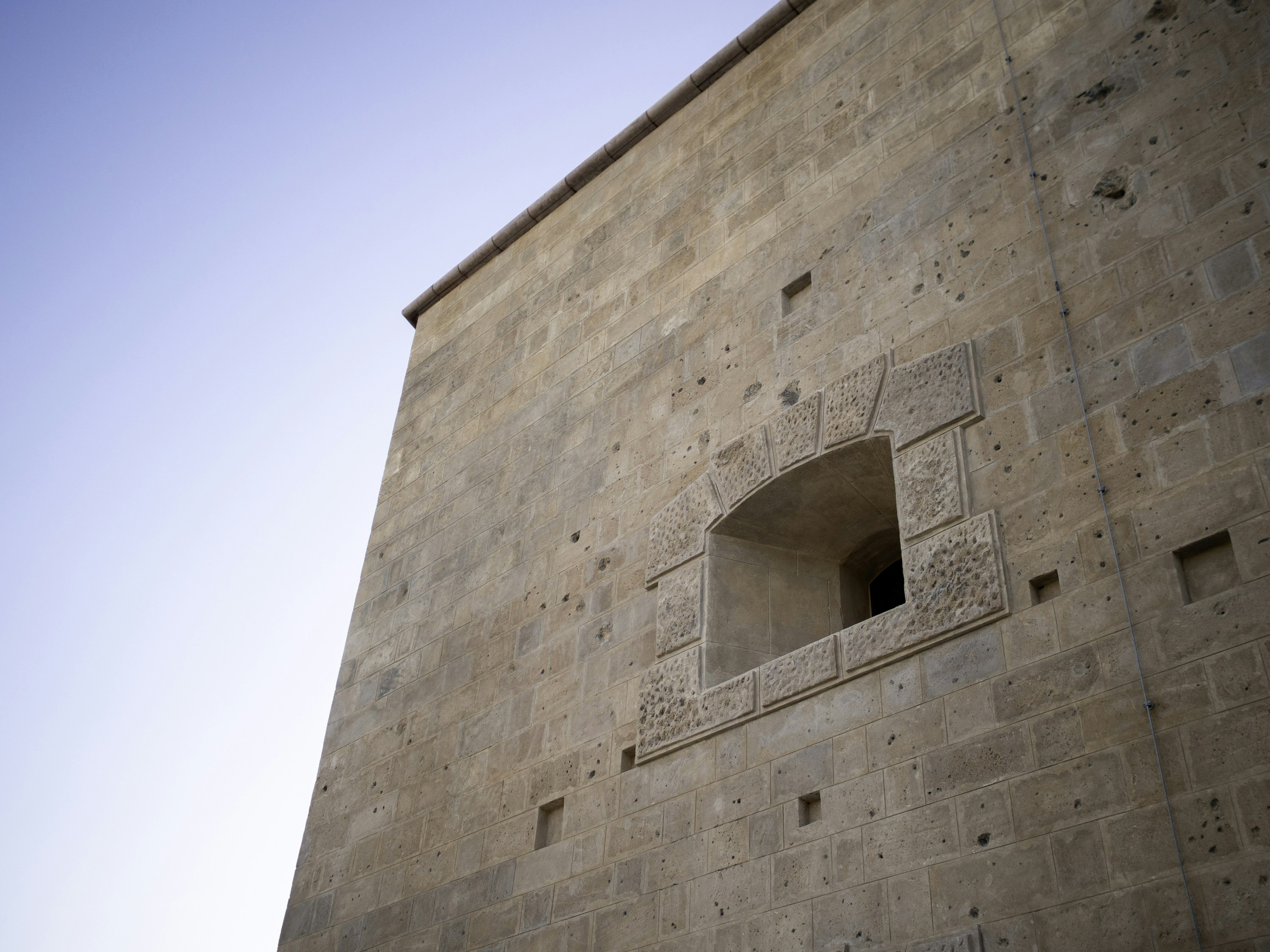 Stone Alchemy: A Window in the Monochrome Facade