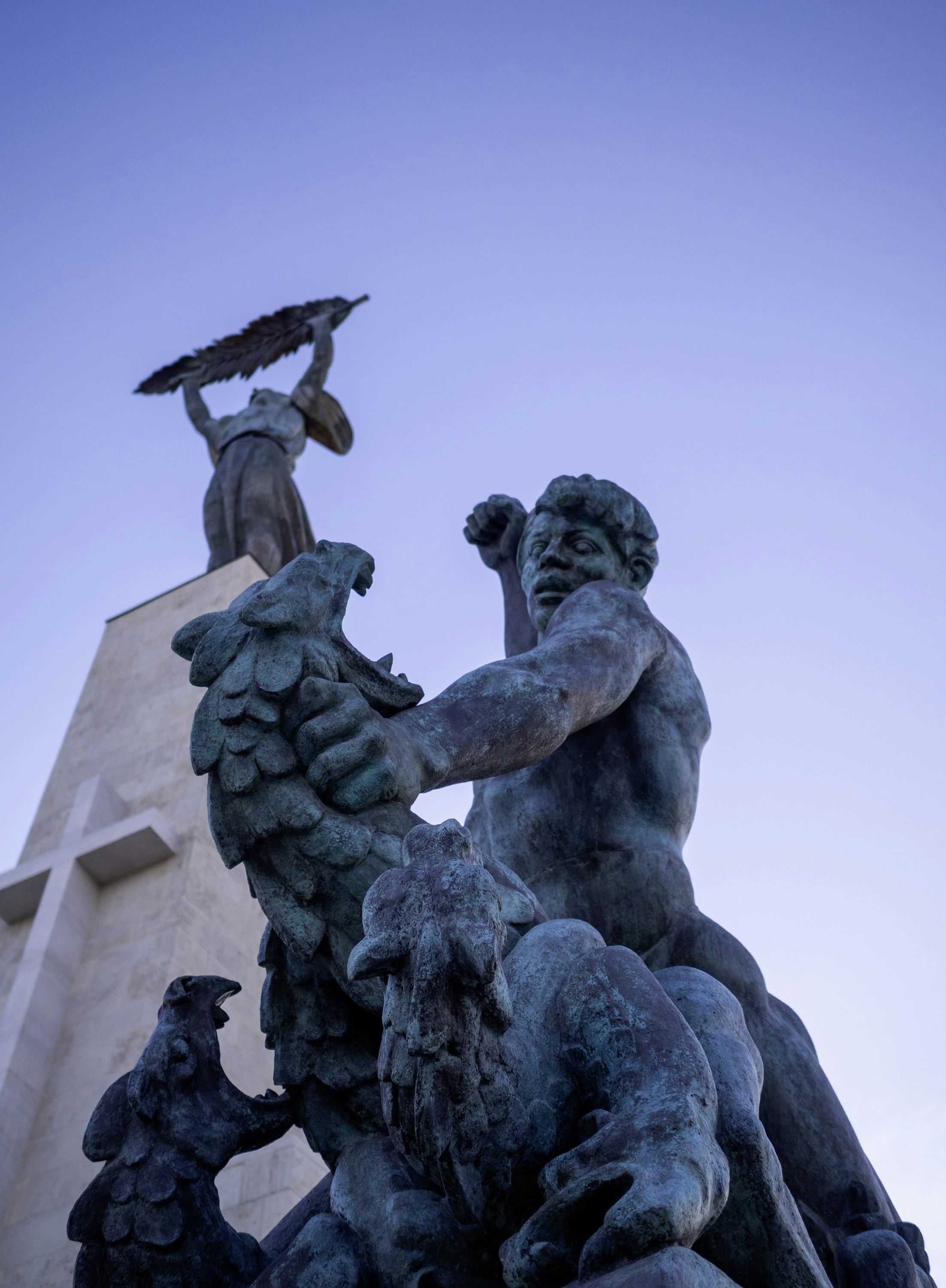 Leaning toward the Sea: A Weathered Bronze Drama Under Blue Sky