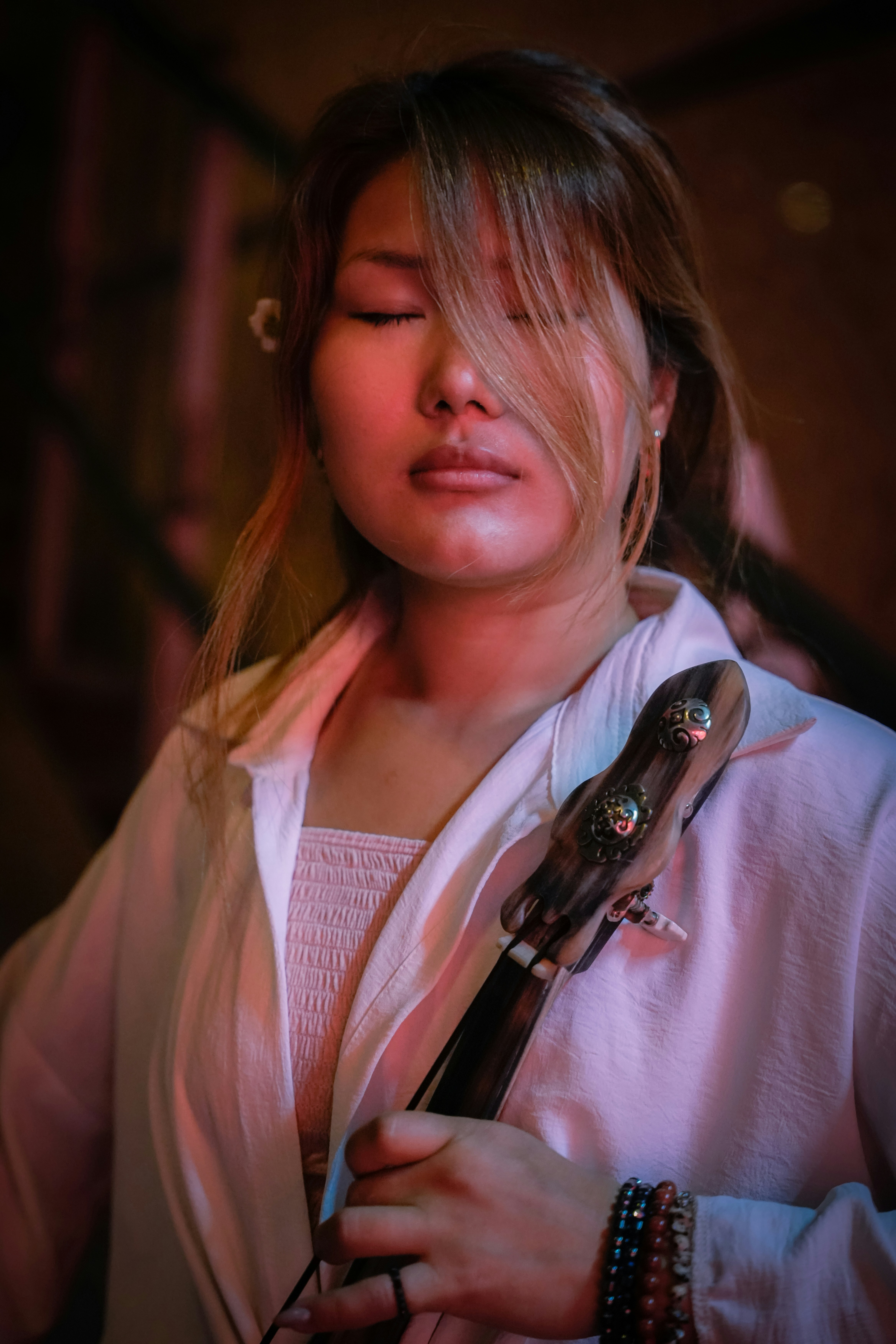 Muted Velvet: A Quiet Moment with a Violin in Soft Neon Light