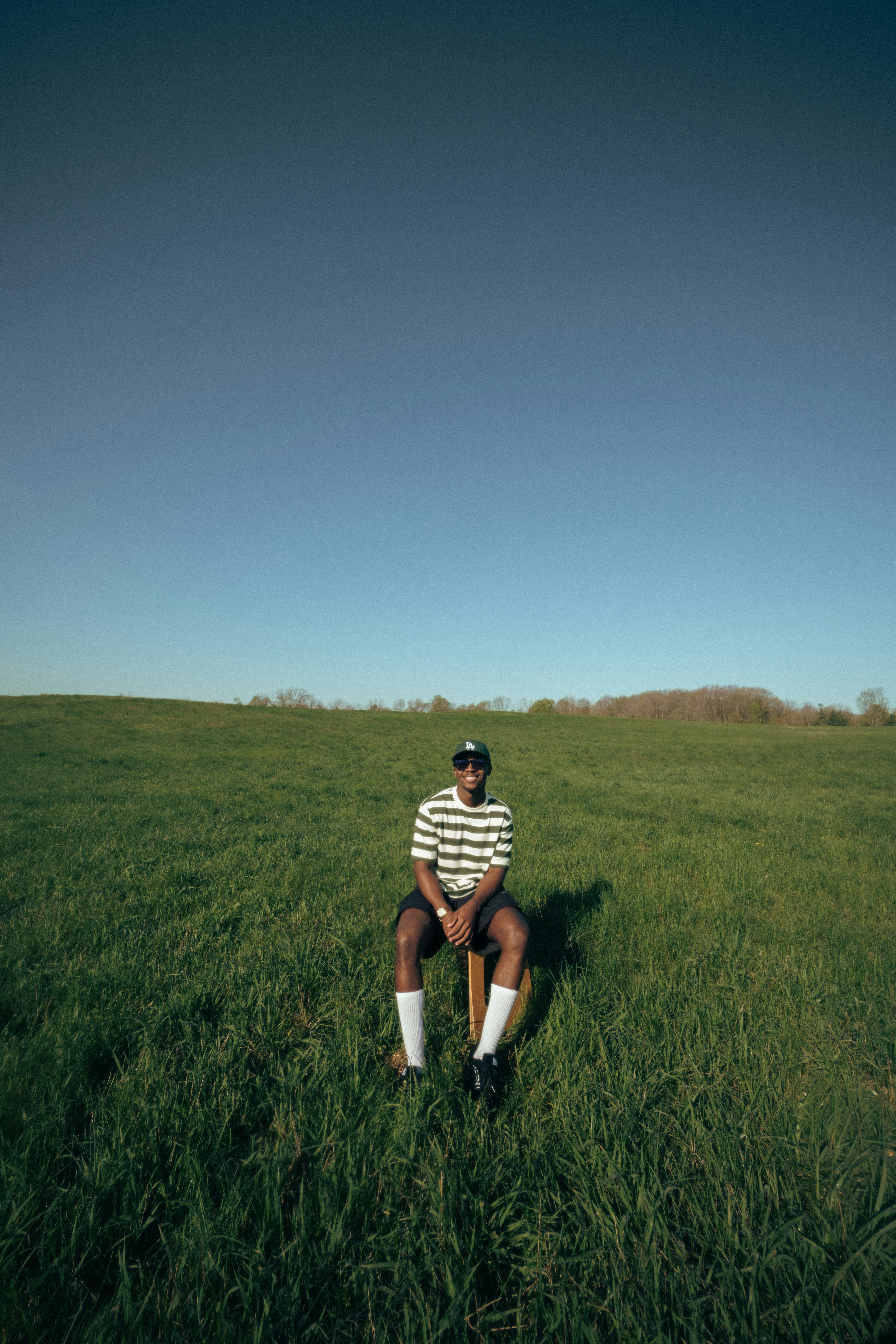 Field Stance: A Lone Figure in the Quiet Green Expanse