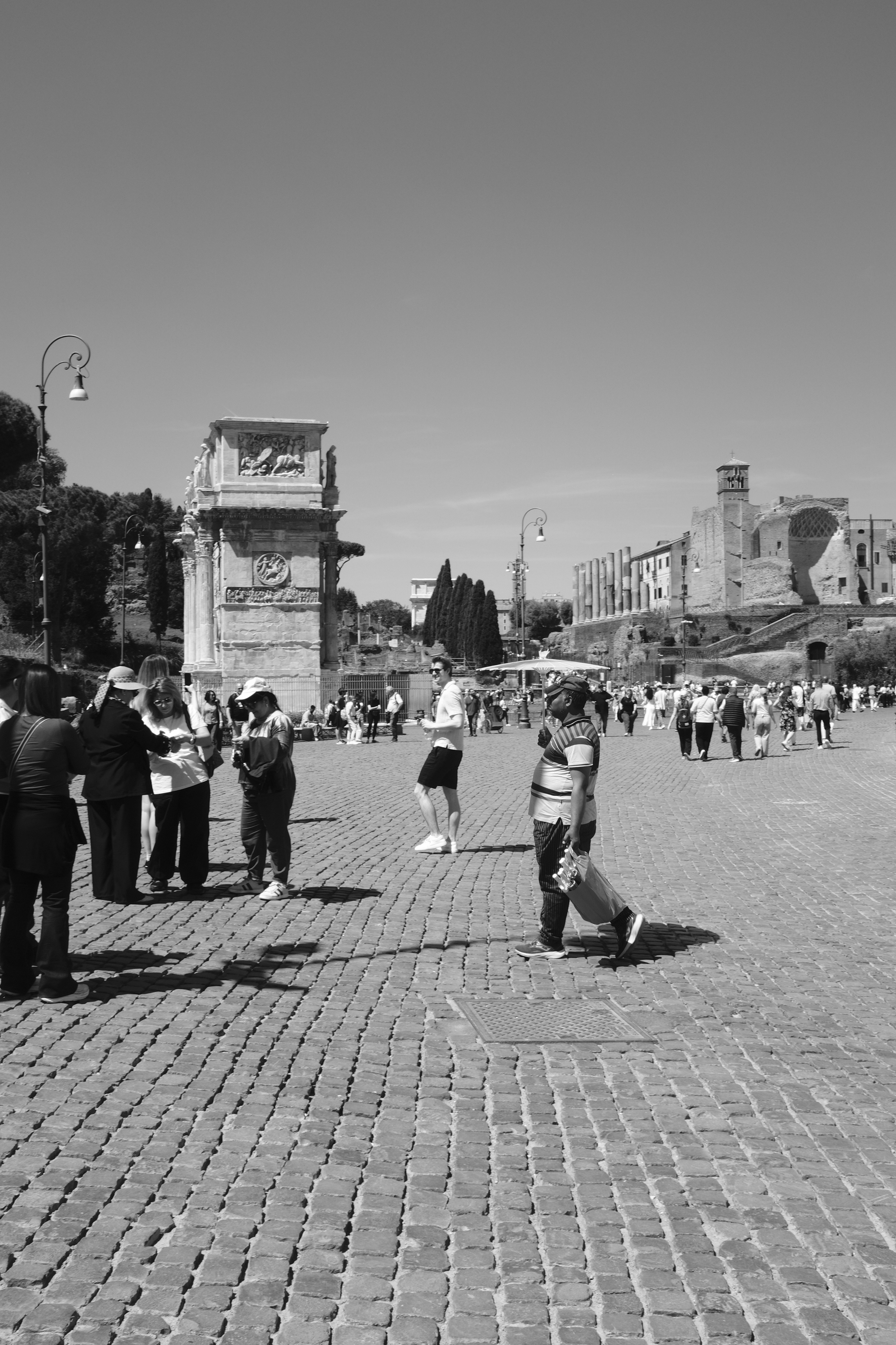 A Quiet Walk Beneath Stone Arches in a Historic Plaza