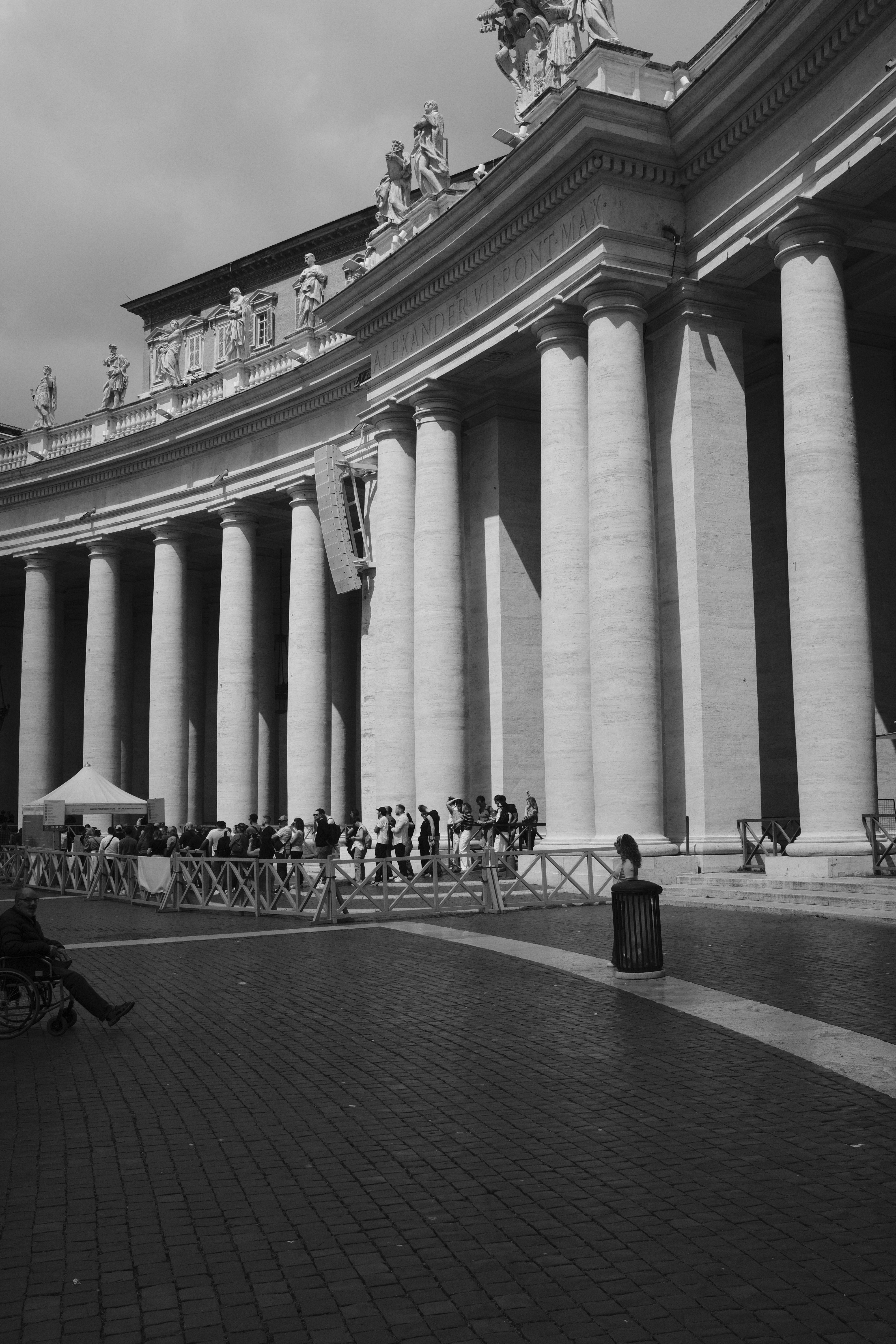 Colonnaded Grandeur: A Quiet Queue Along the Arcaded Facade