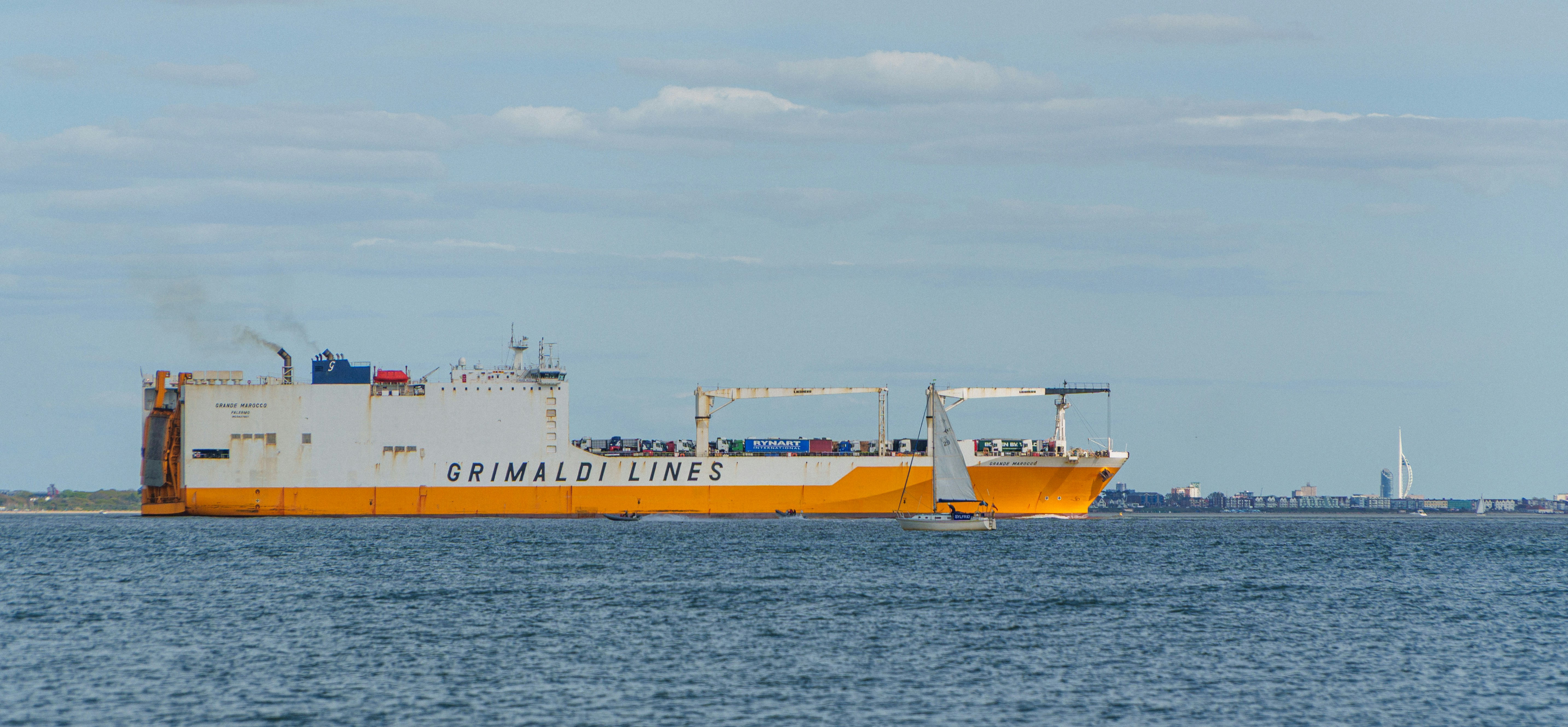 Grain-Orange Horizon: A Grimaldi Lines Freighter on Calm Seas