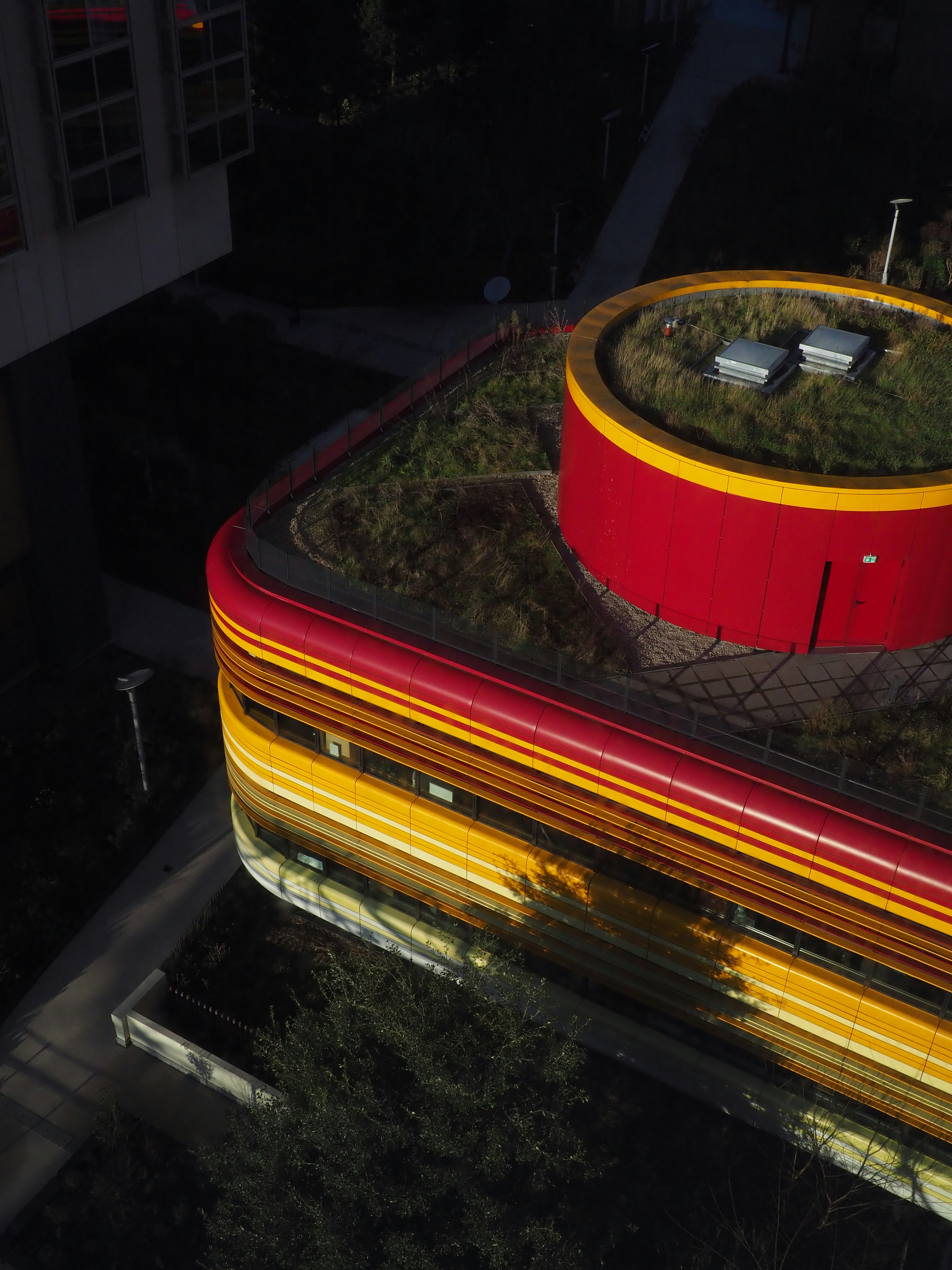Vivid Circular Roofline: A Neon-Draped Building From Above