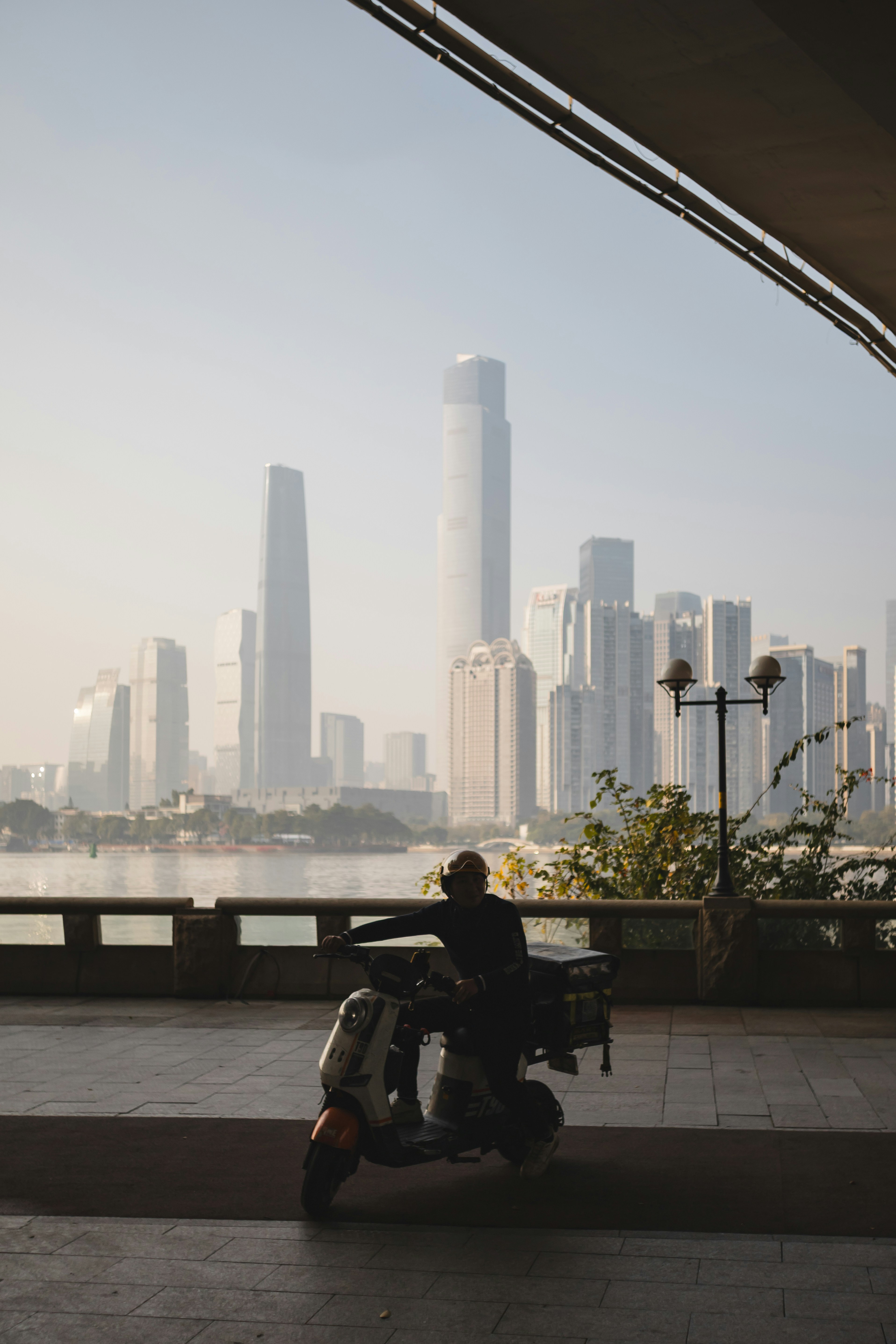 Cityscape Rider: A Quiet Moment Beneath the Skyscrapers