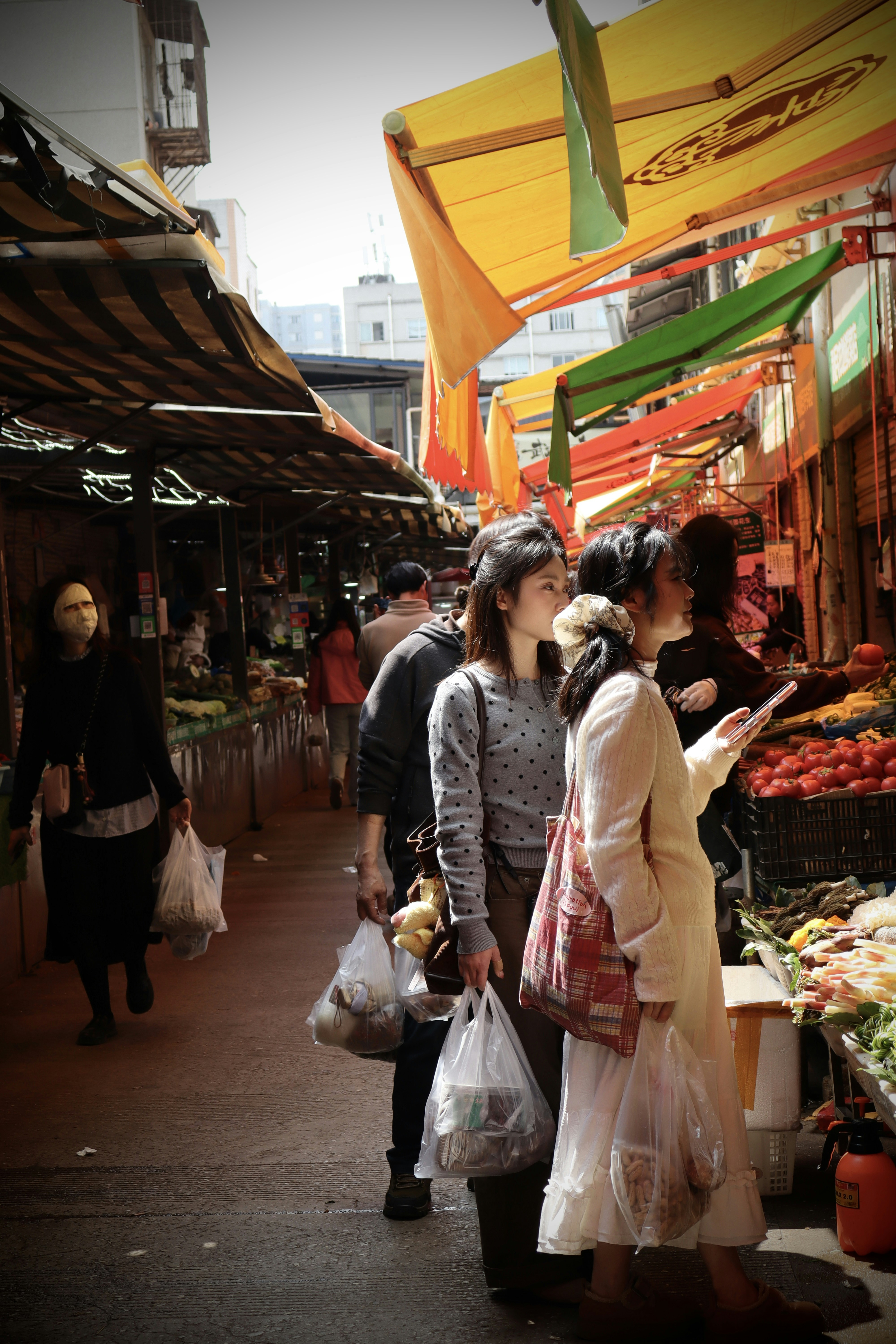 Market Portrait Under Colorful Canopy