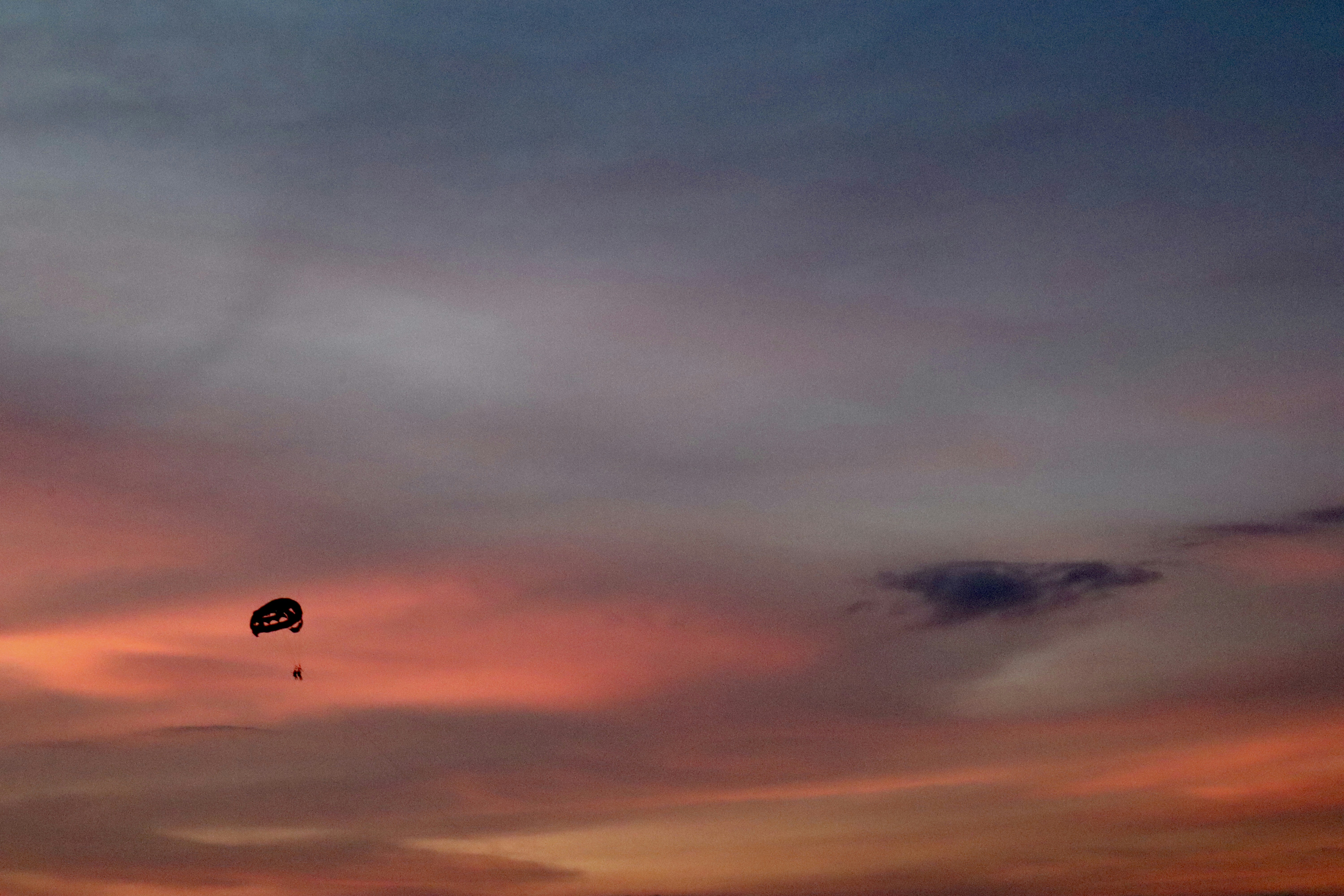 Silhouette Descent: Parachute Dawn over a Quiet Horizon
