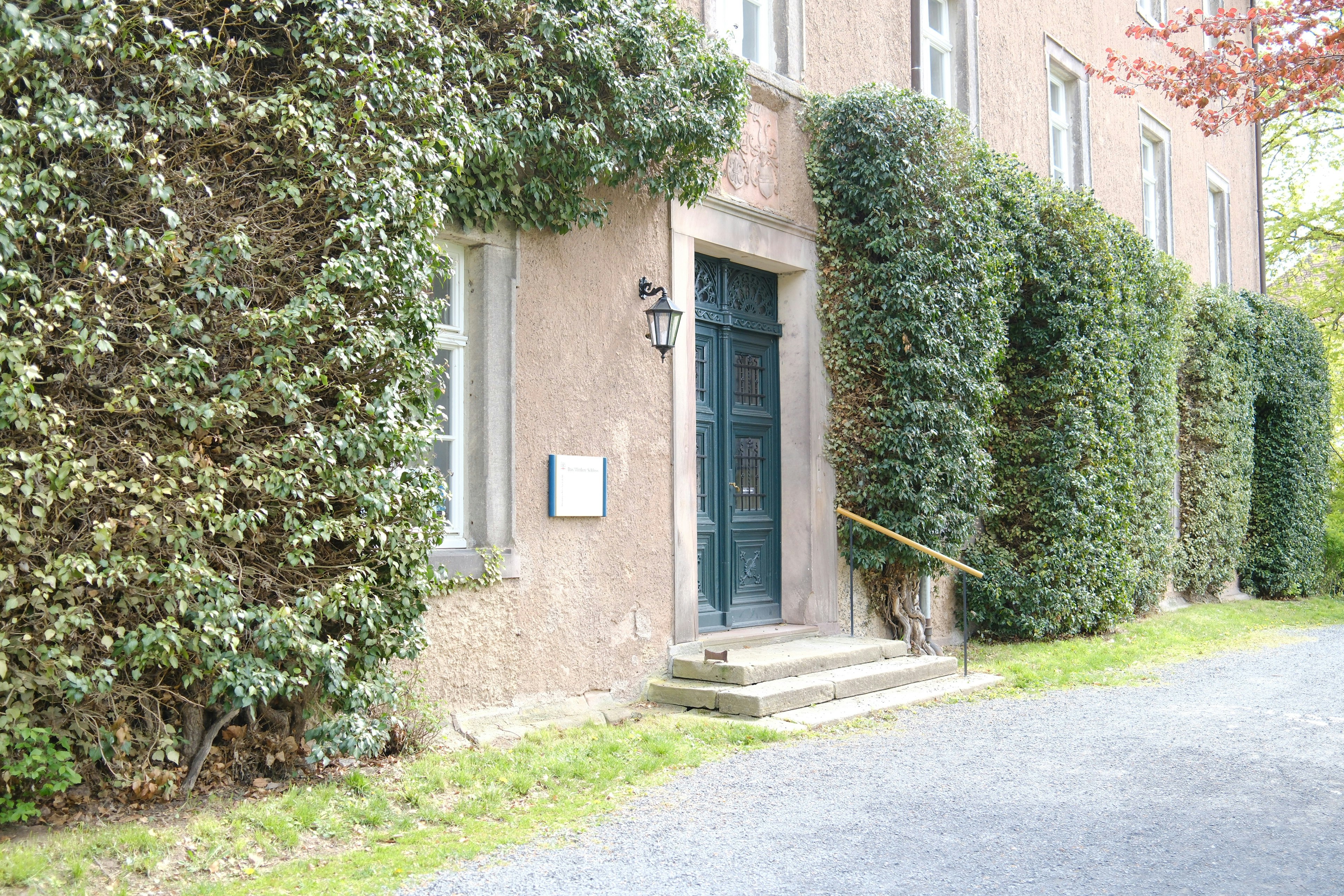 Green-tinted Steps to a Deep-Set Door