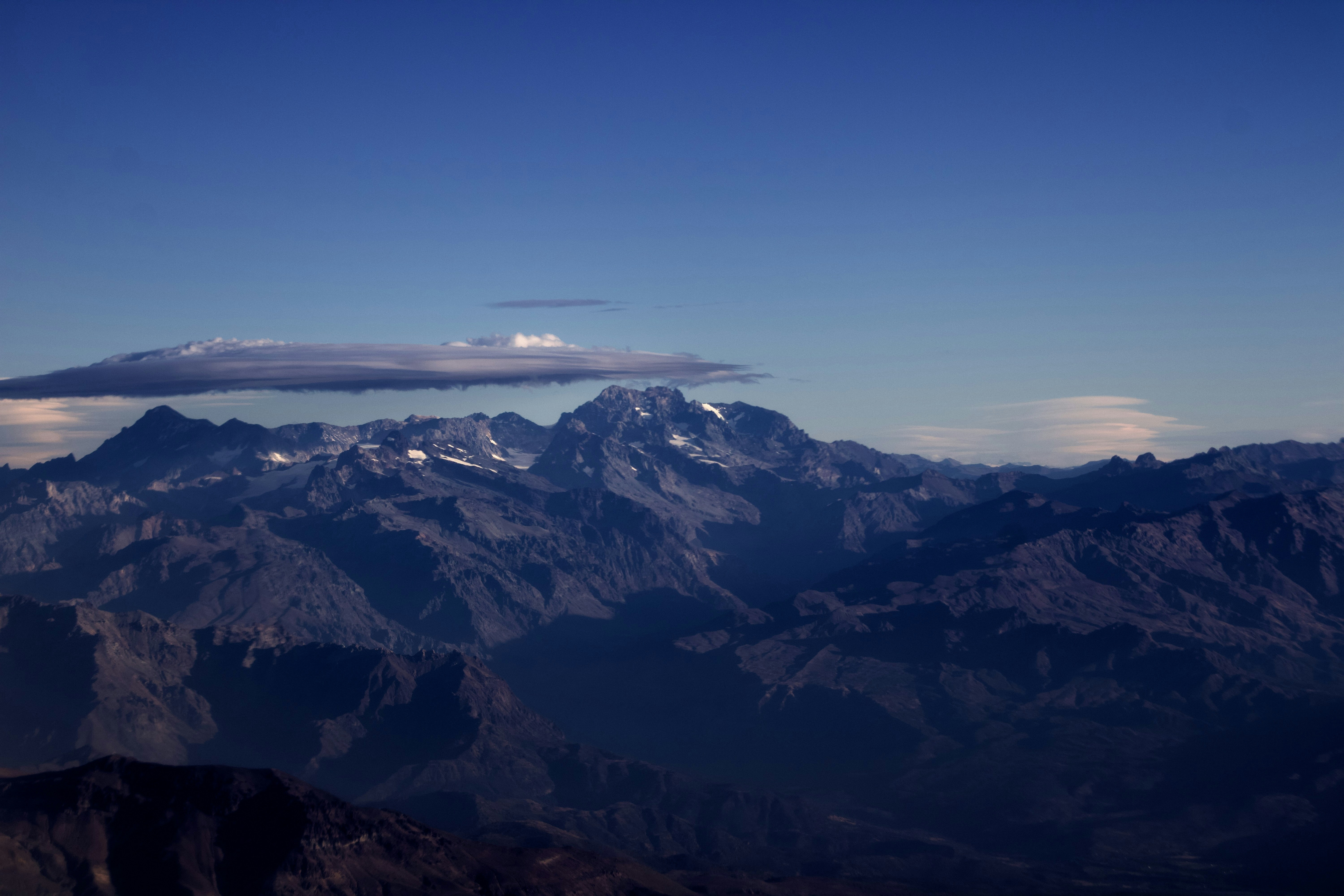 Azure Horizon: A Snow-Dusted Crown Over the Alpine Range