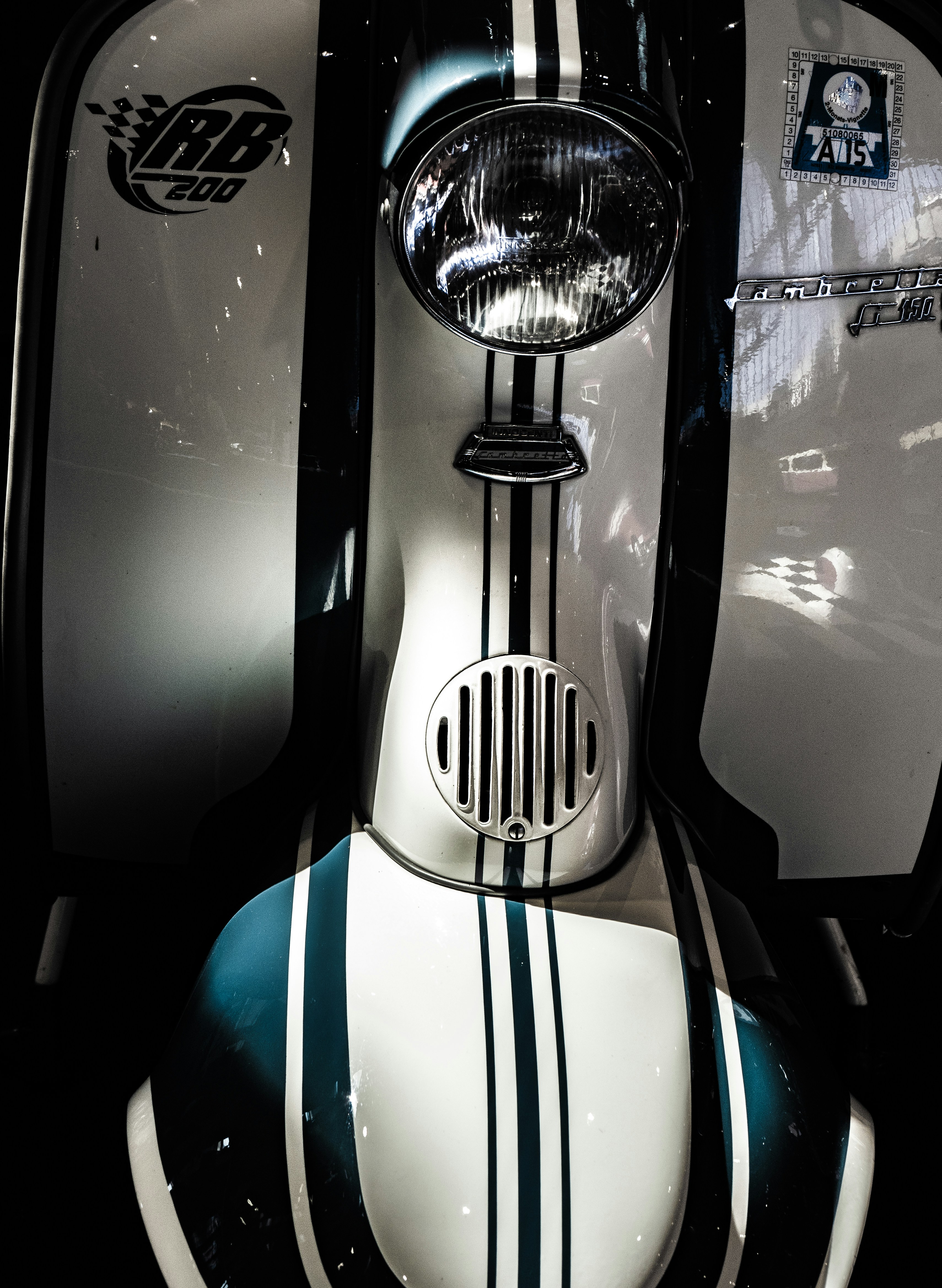 Central Headlamp and Striped Crest: A Retro Scooter Portrait