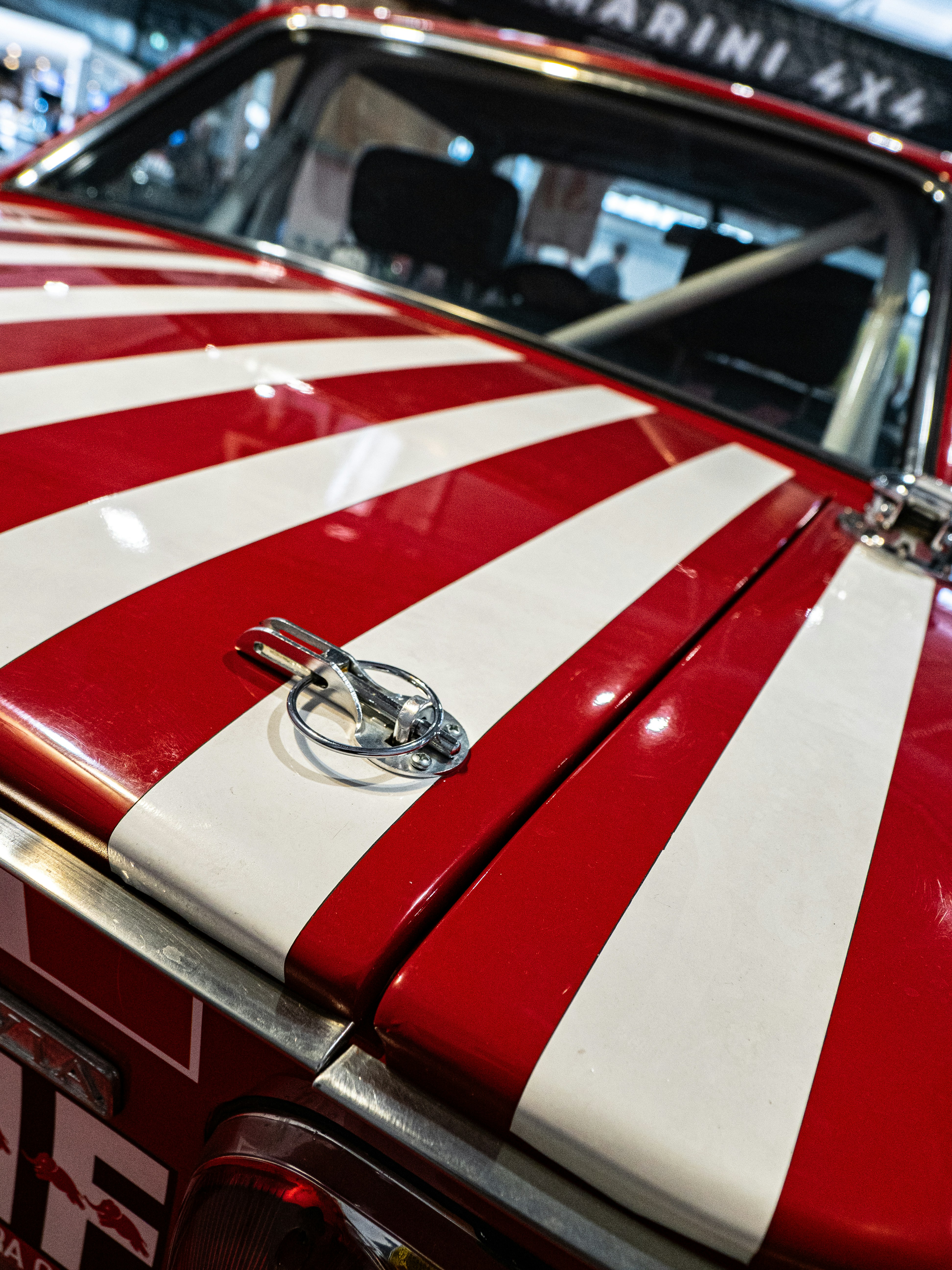 Stripes of Chrome: A Hooded Glimpse of a Classic Muscle Car