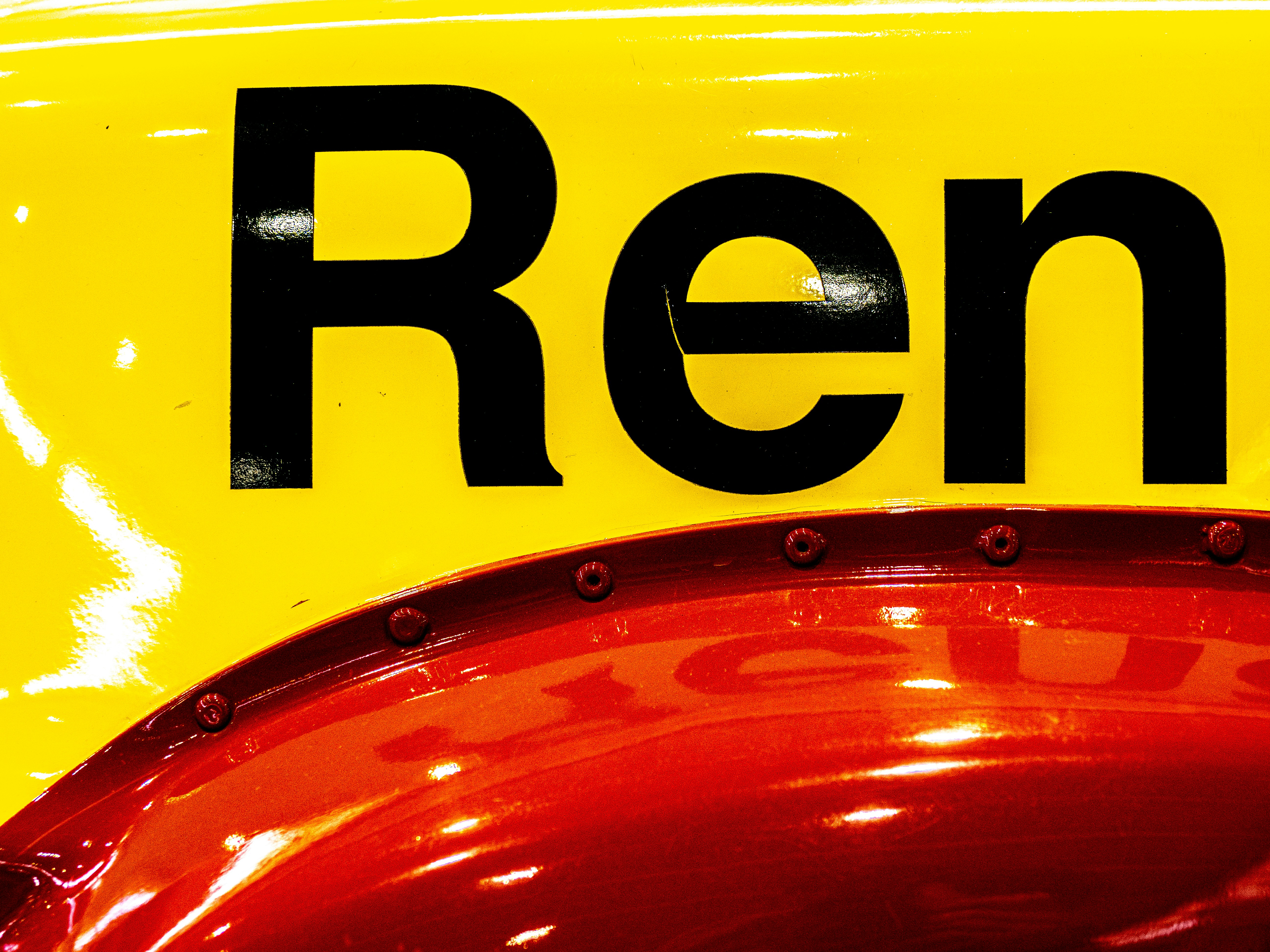 Bright Yellow and Red Curve: Close-Up of Enamelized Sign Jumble