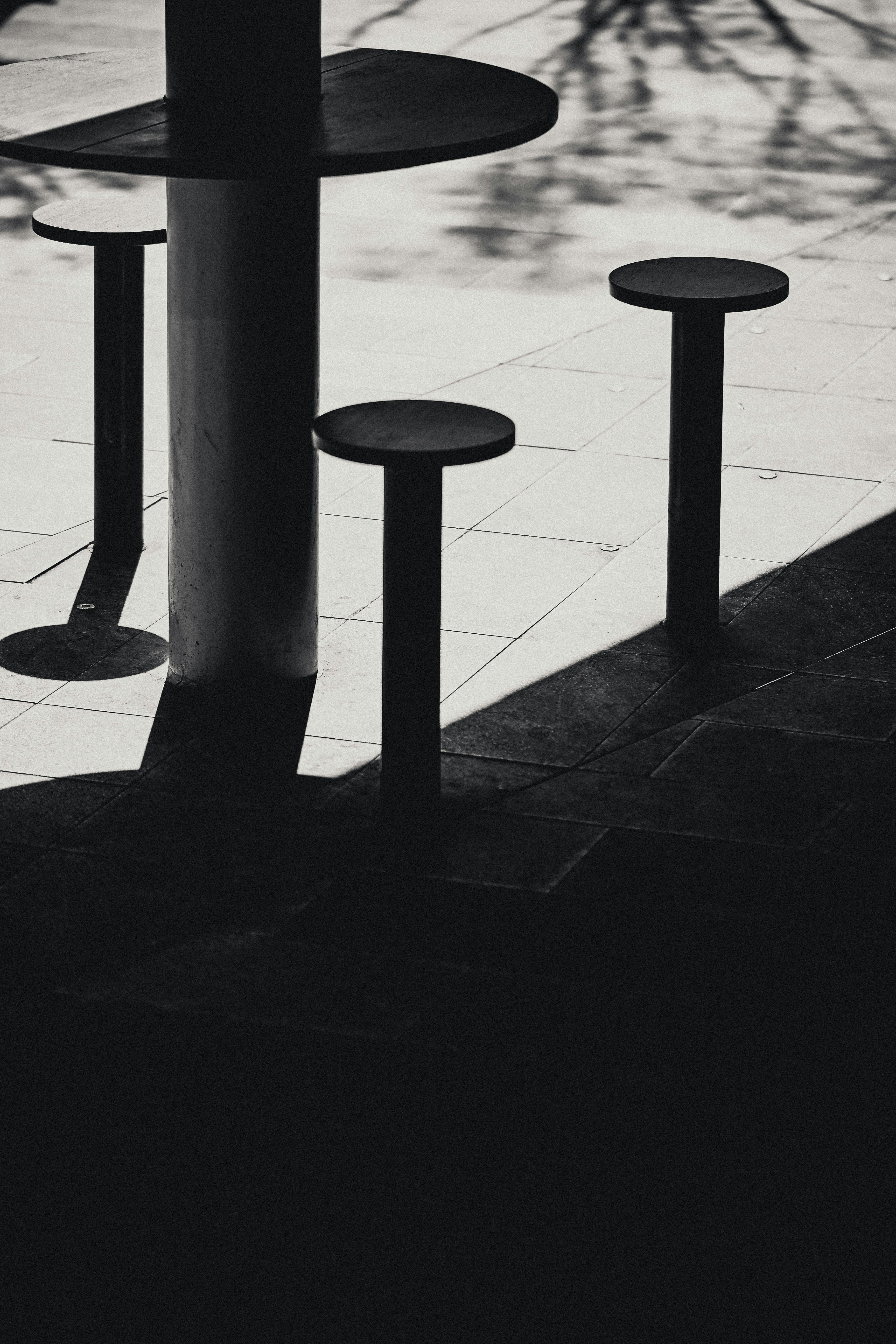 Shadow Play on Concrete: Minimal Steel Stands at Dusk