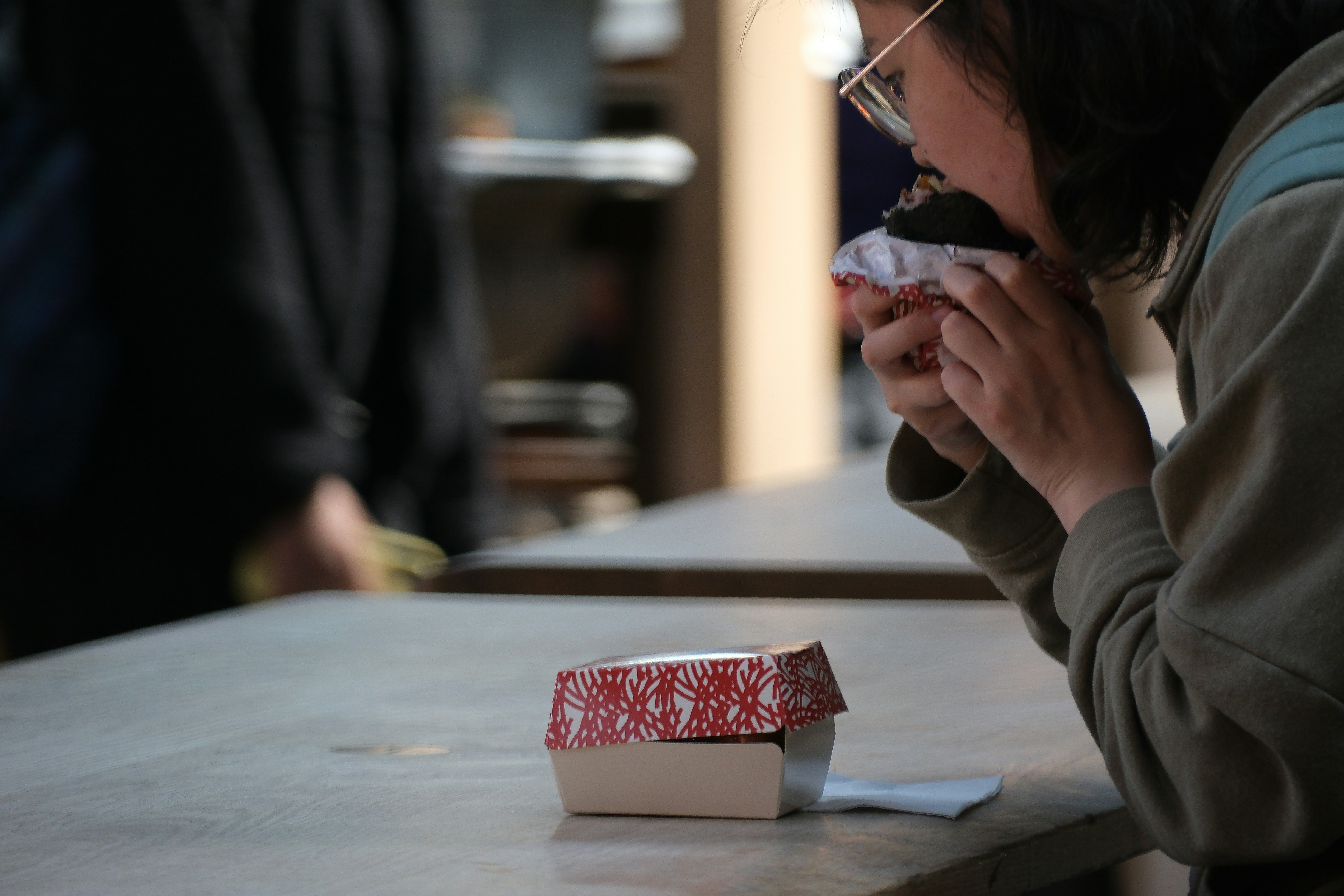 Close-up of a quiet bite: a moment of sharing a dessert at a table