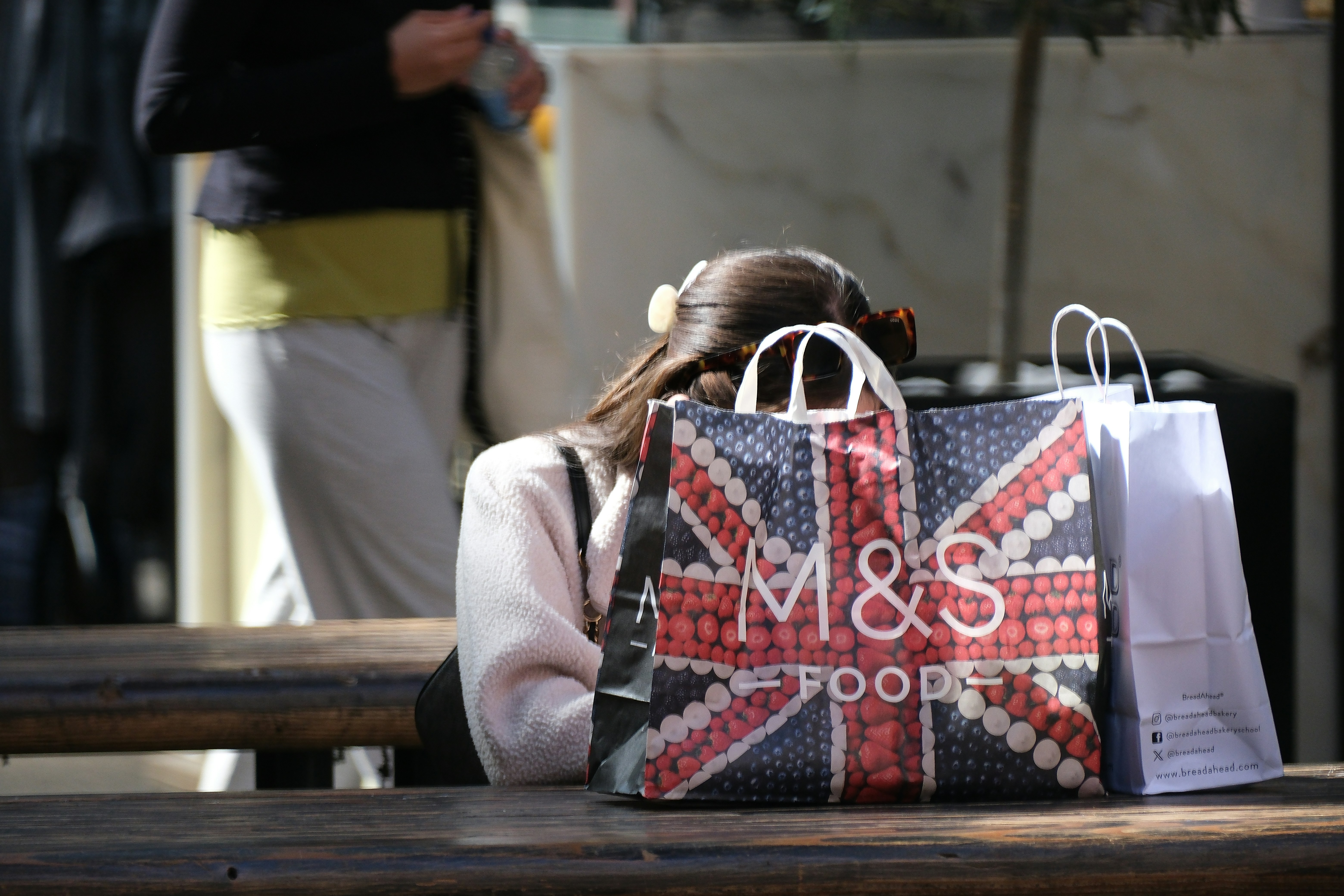 M&S Food Bag on a Park Bench: A Moment of Quiet amidst Street Visual Noise