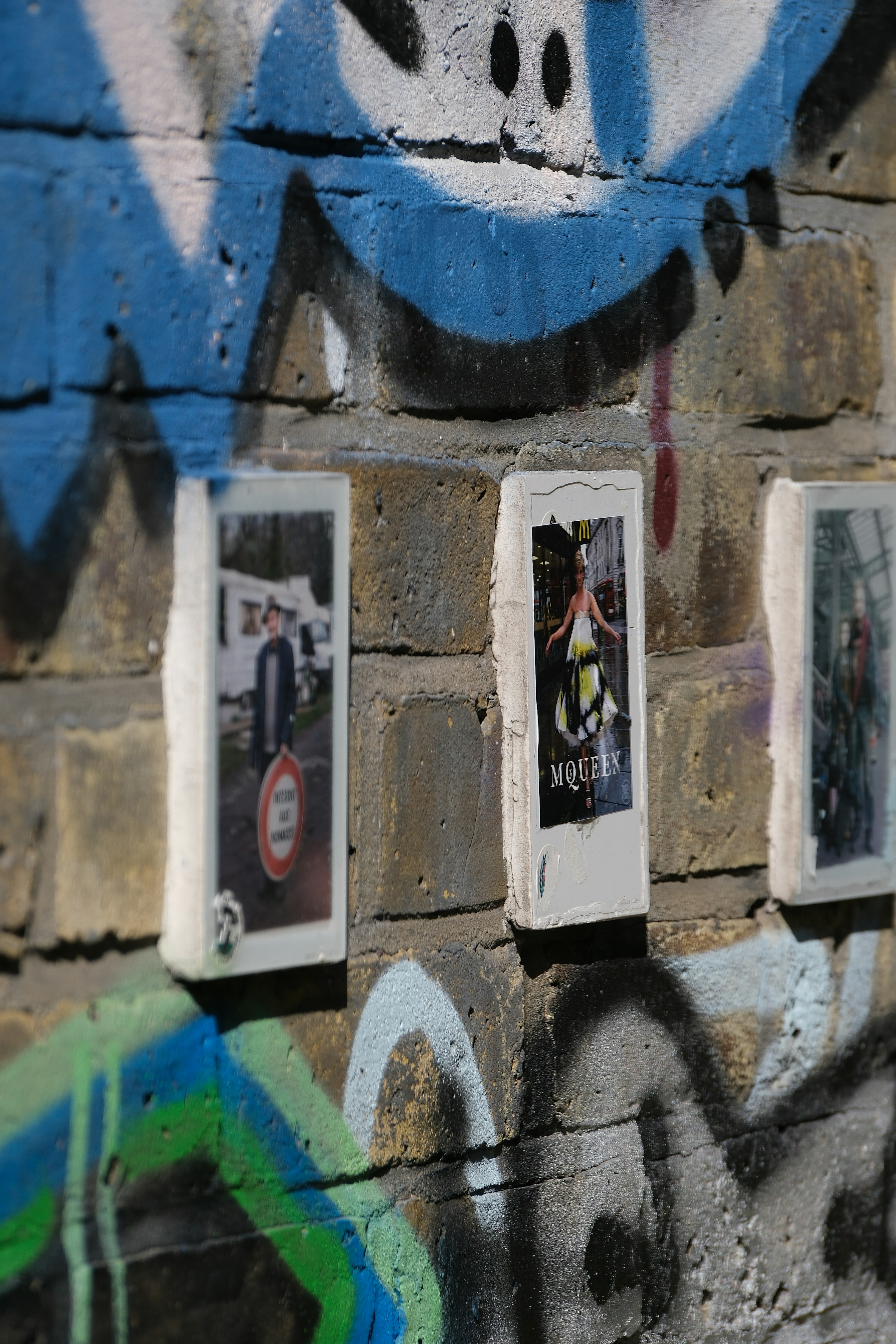 Polaroids on a Graffitied Brick Wall
