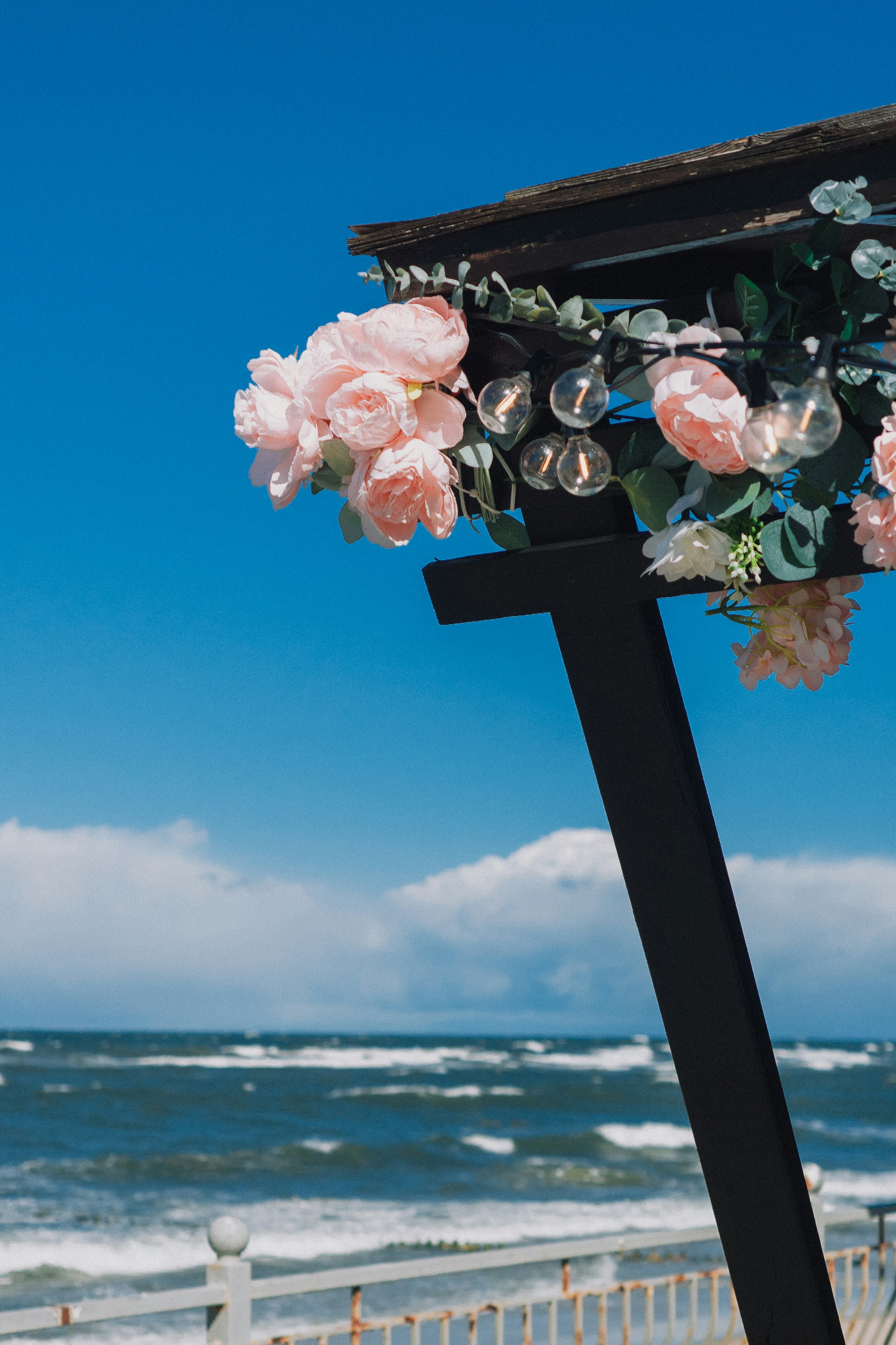 Floral Archway Over Ocean Waves