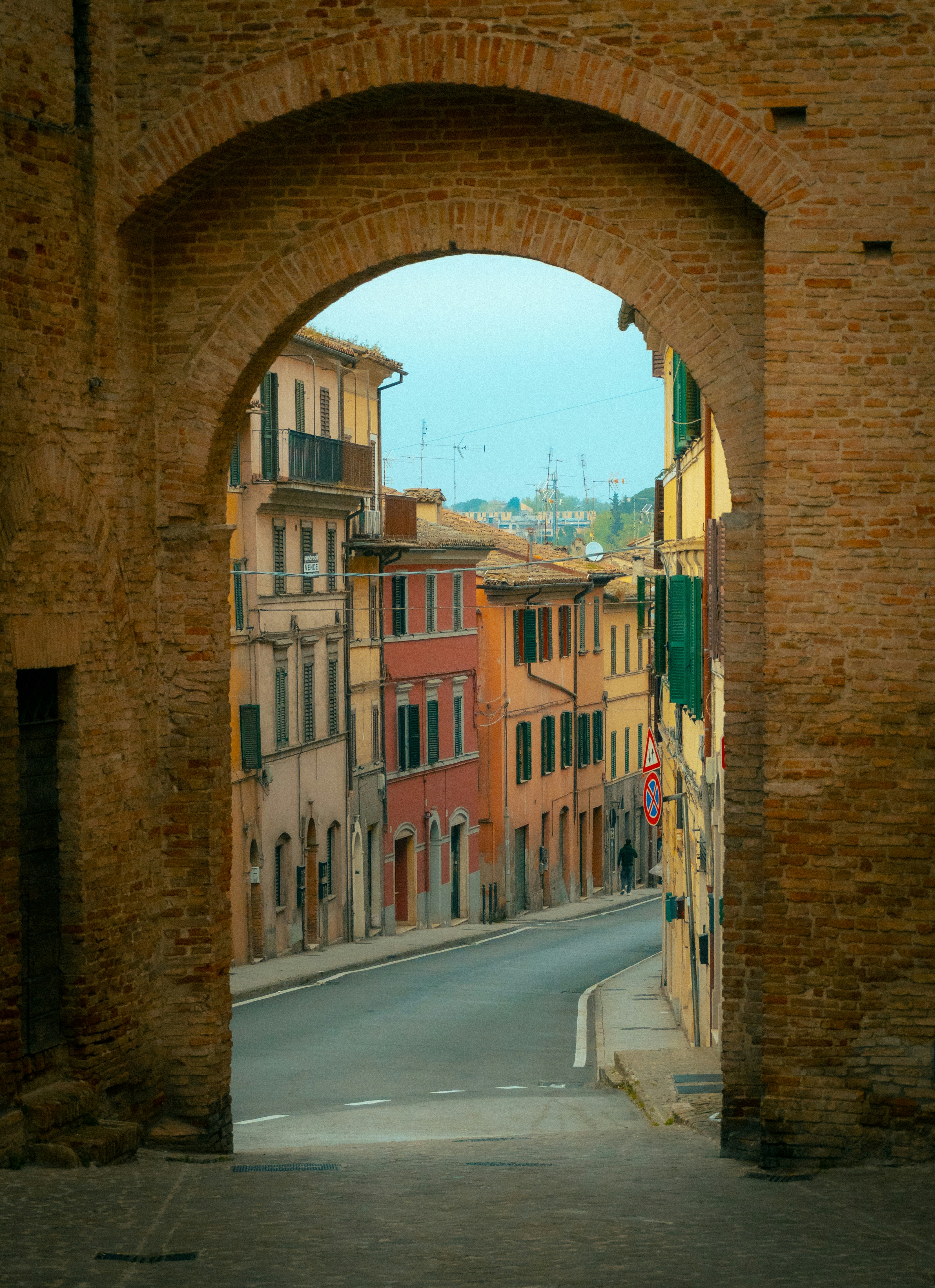 Through the Stone Archway to a Colorful Street
