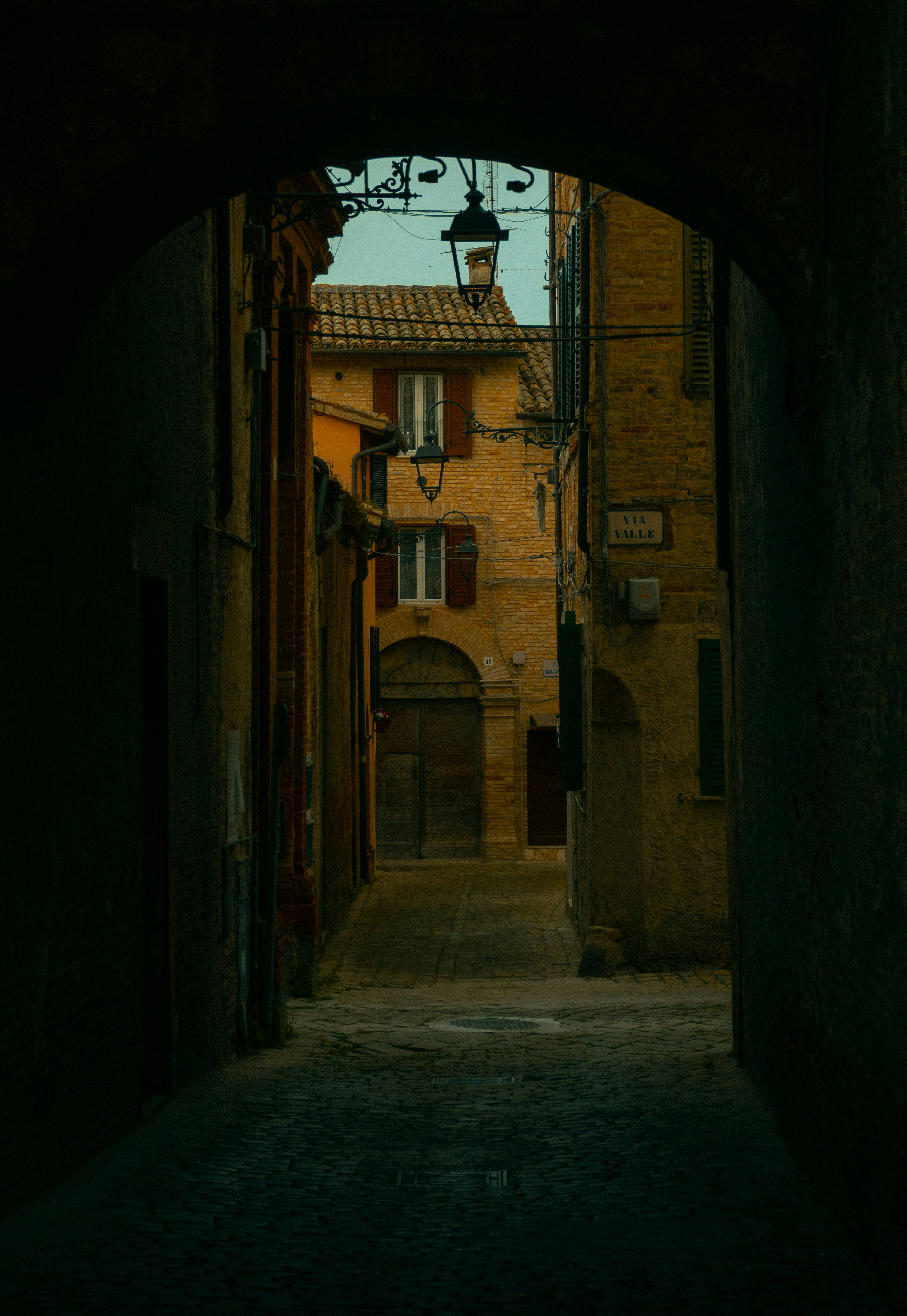 Lanterned Passage: Quiet Street Through the Arch
