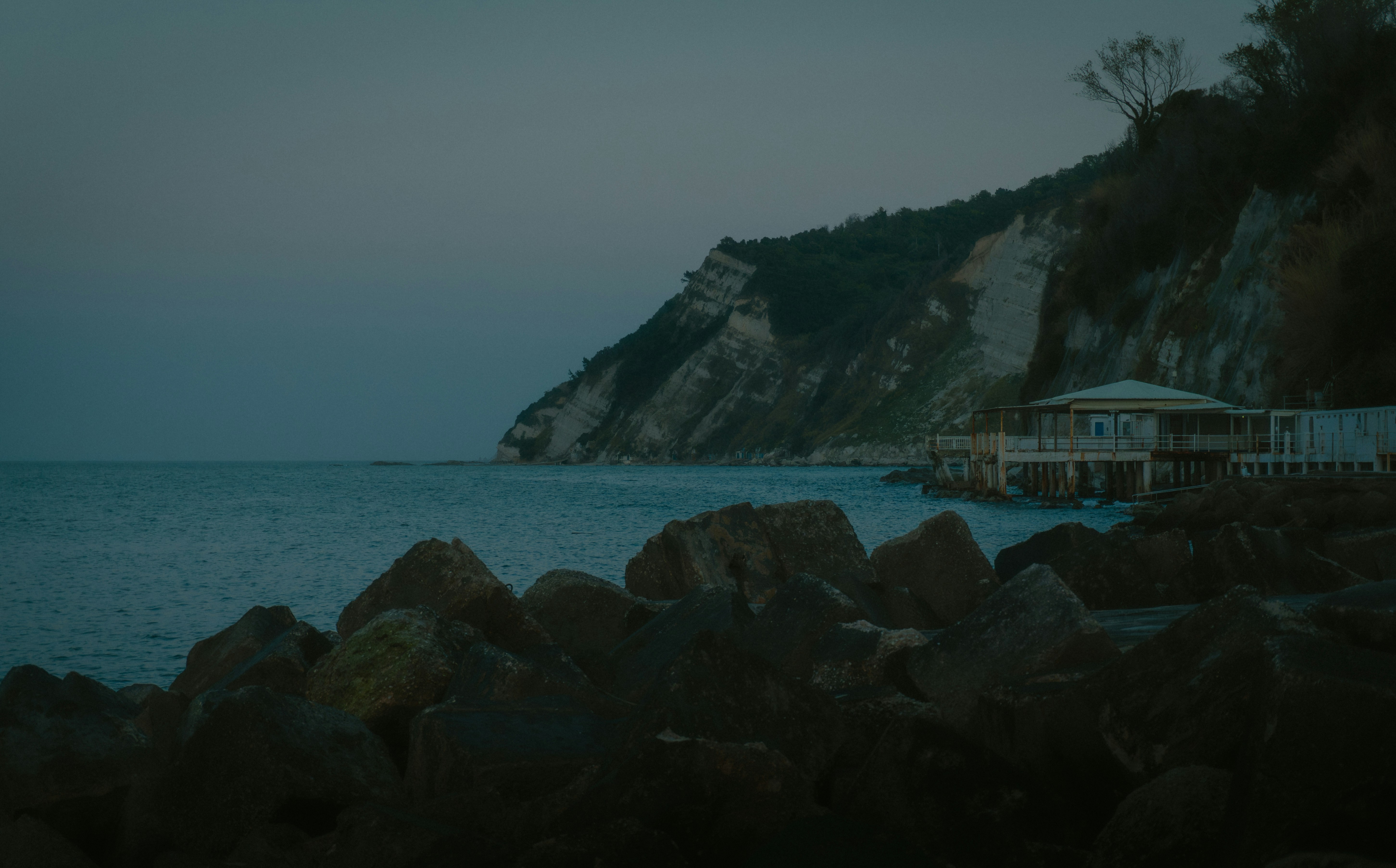 Rugged Seascape: A Quiet Pier at Dusk