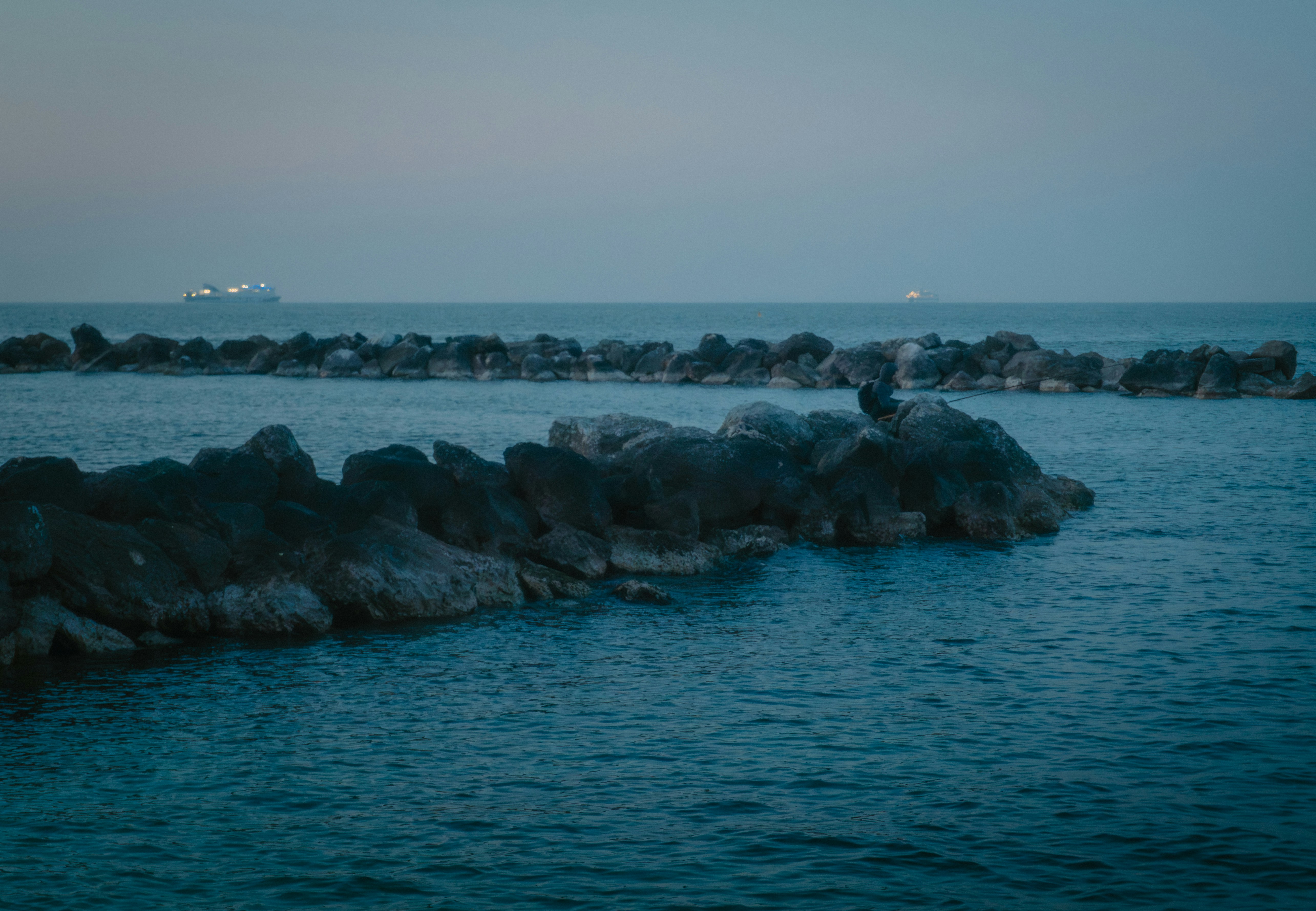 Rocks on a Calm Sea: A Serene Coastal Line