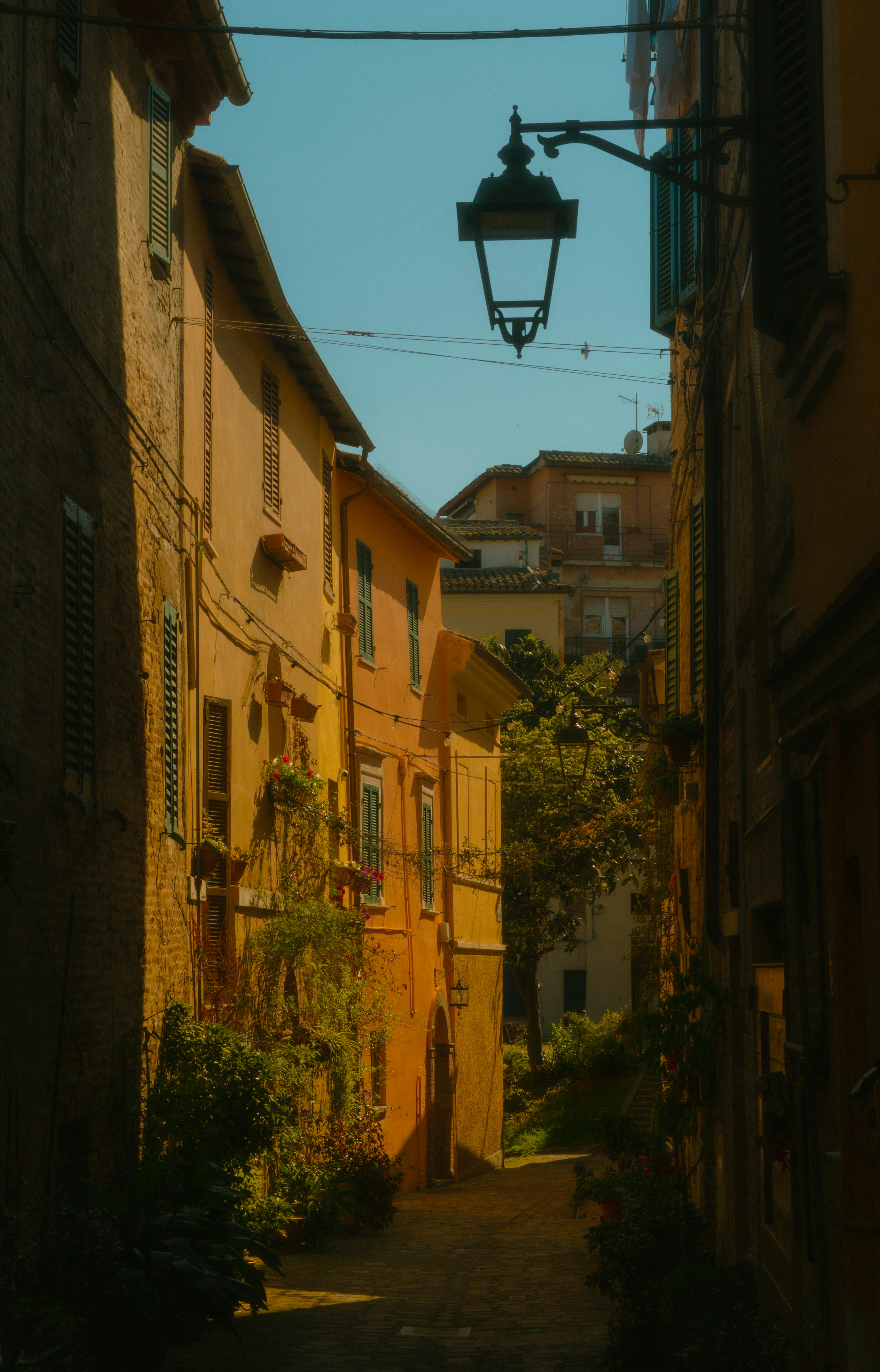 Golden Street Corridor with Warm Facades and Sunlit Archway