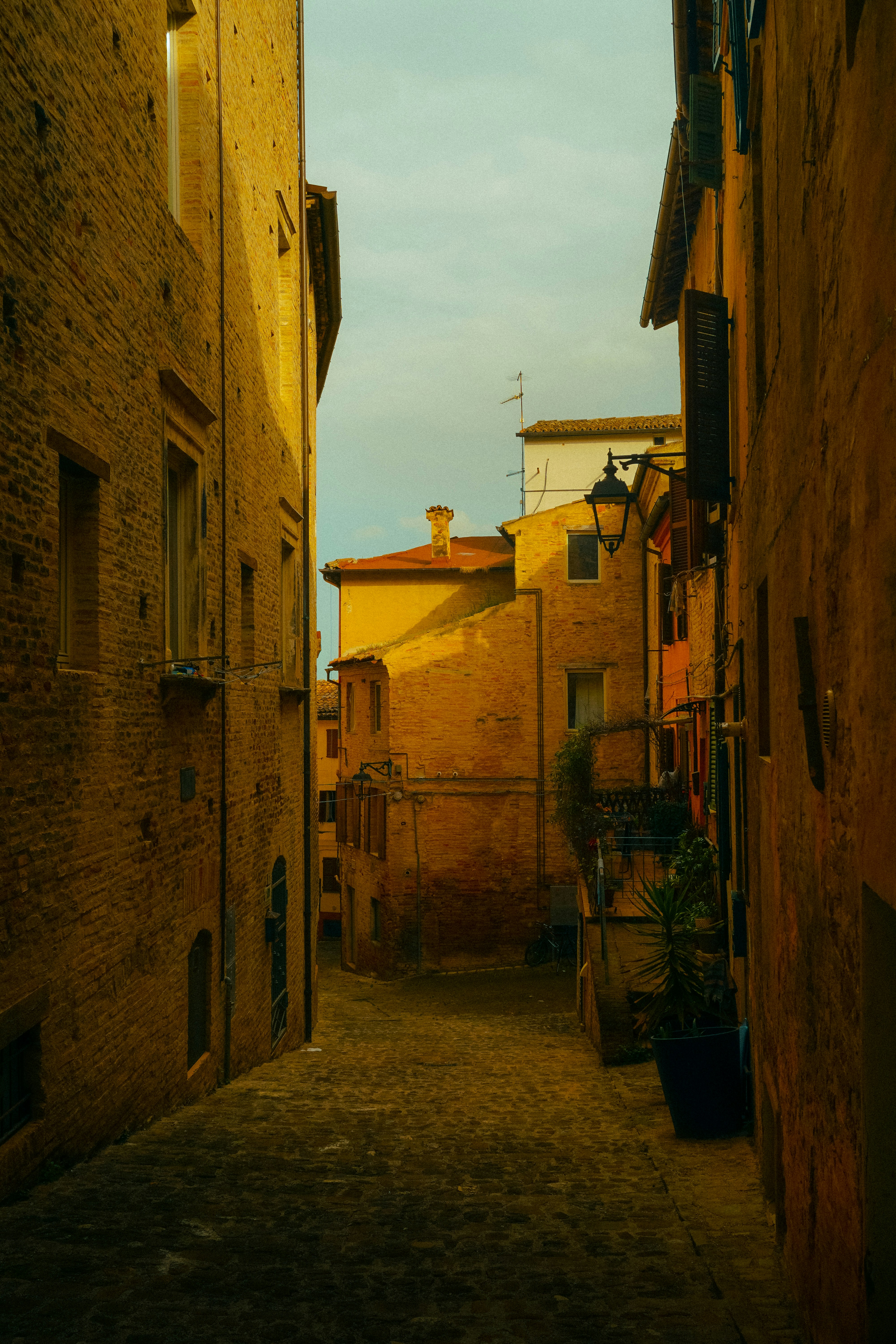 Golden Hour Alleyway Between Brick Facades
