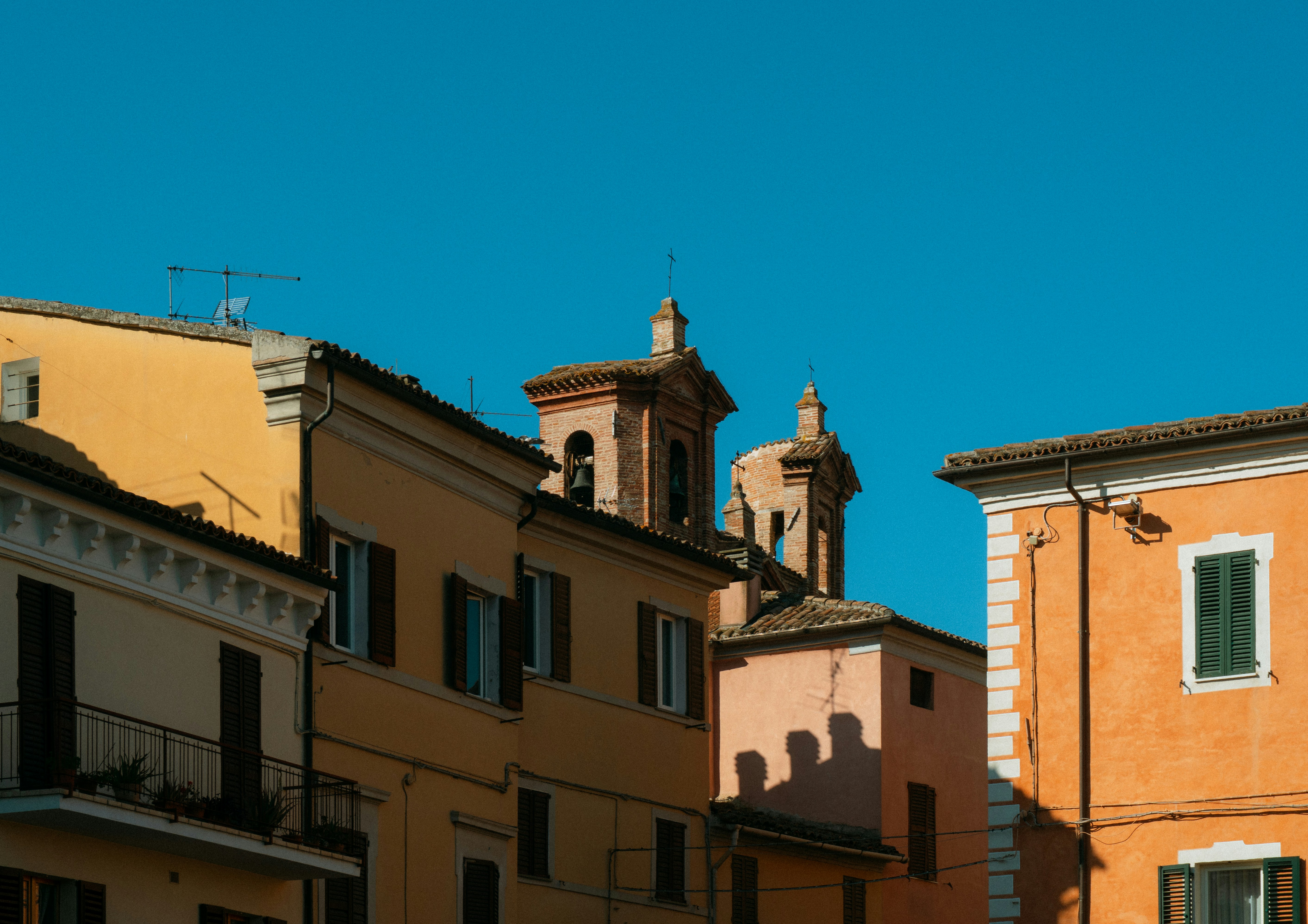 Terracotta City Roofline under a Clear Teal Sky
