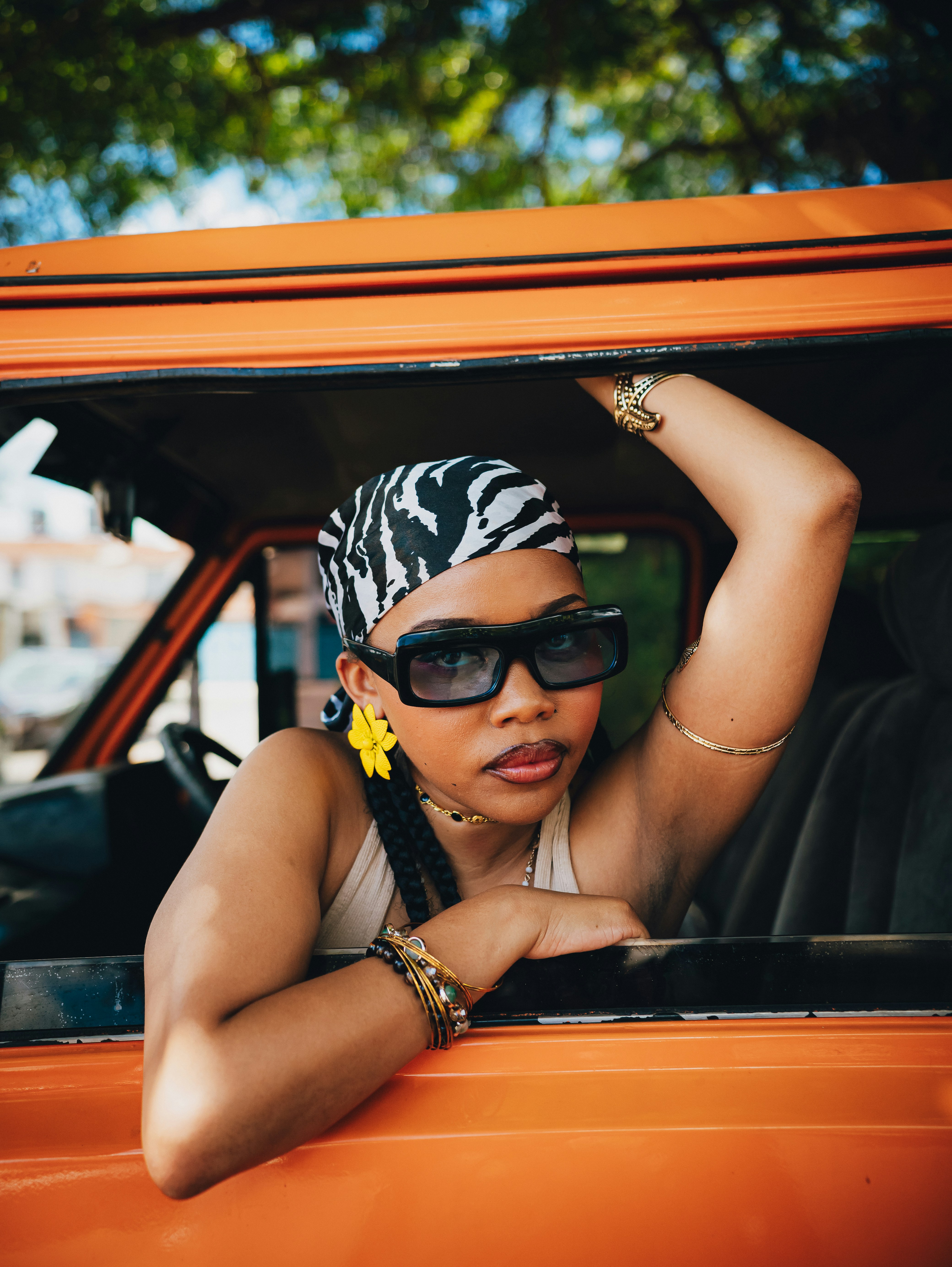 Confidence in the Driver's Seat: A Chrome-orange Ride and Bold Attire
