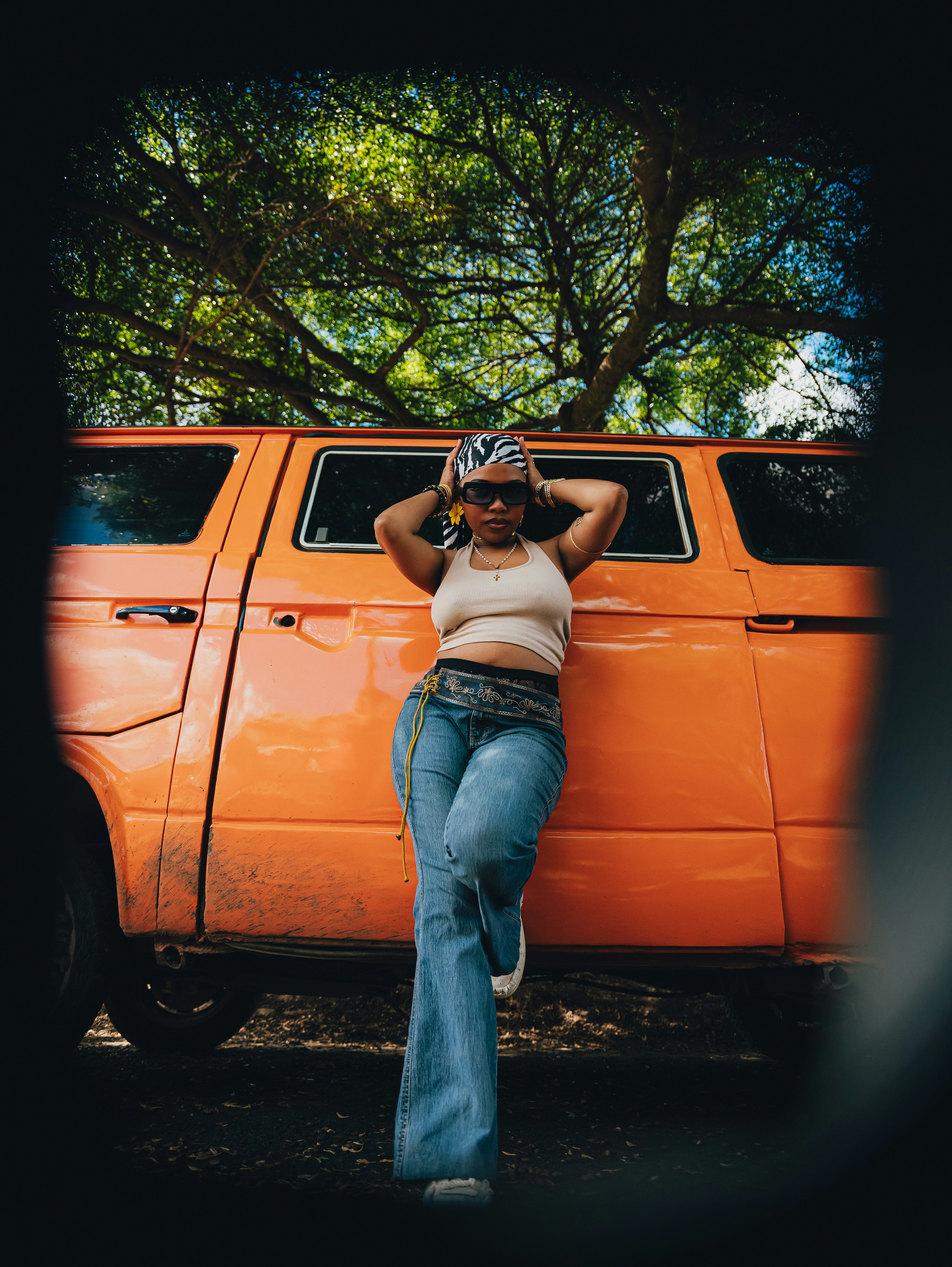 Orange Ride, Cool Confidence: A Woman Strikes a Pose by a Vintage Van