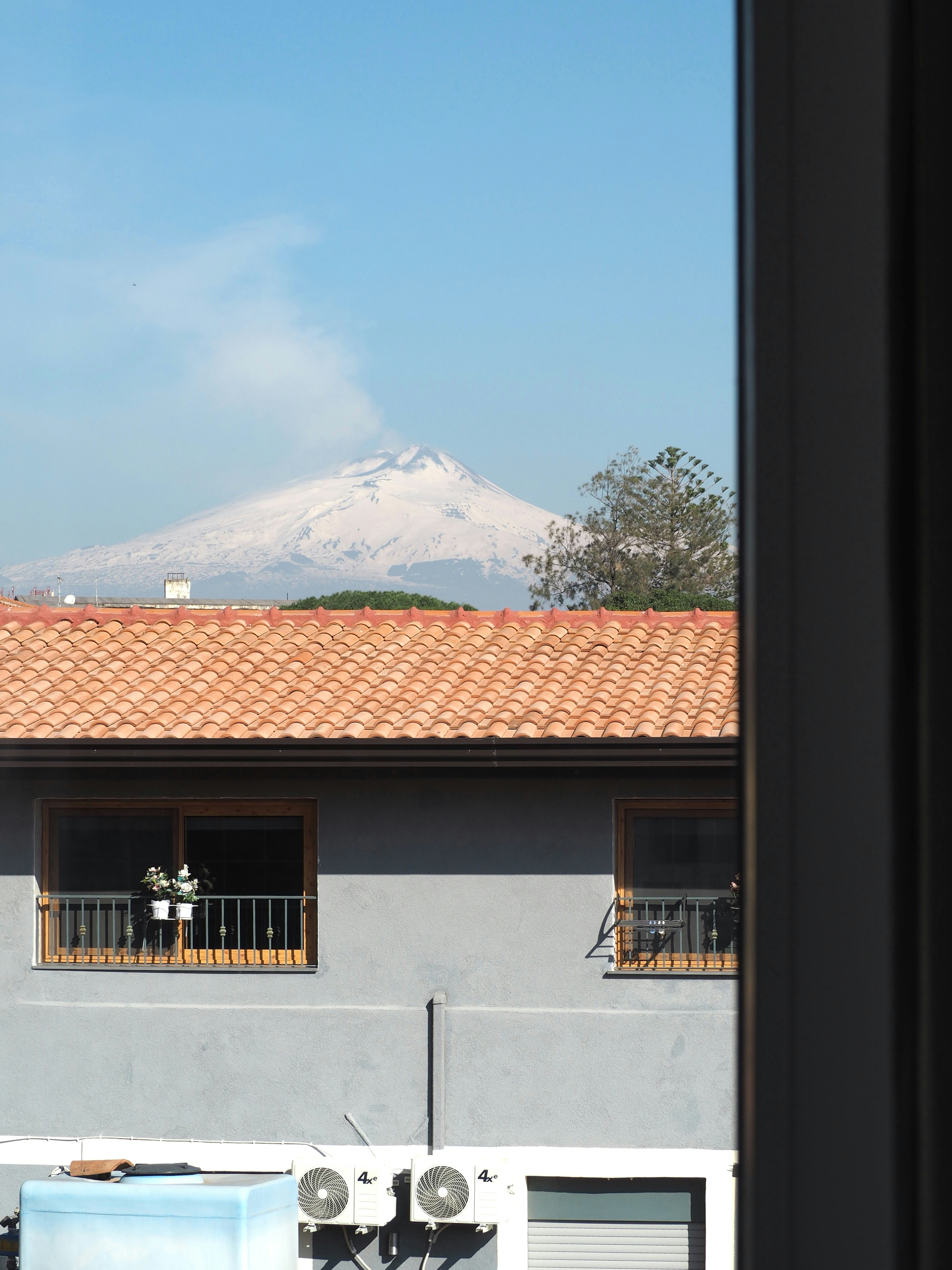 Snow Peak Beyond the Terrace: A Quiet Urban Frame