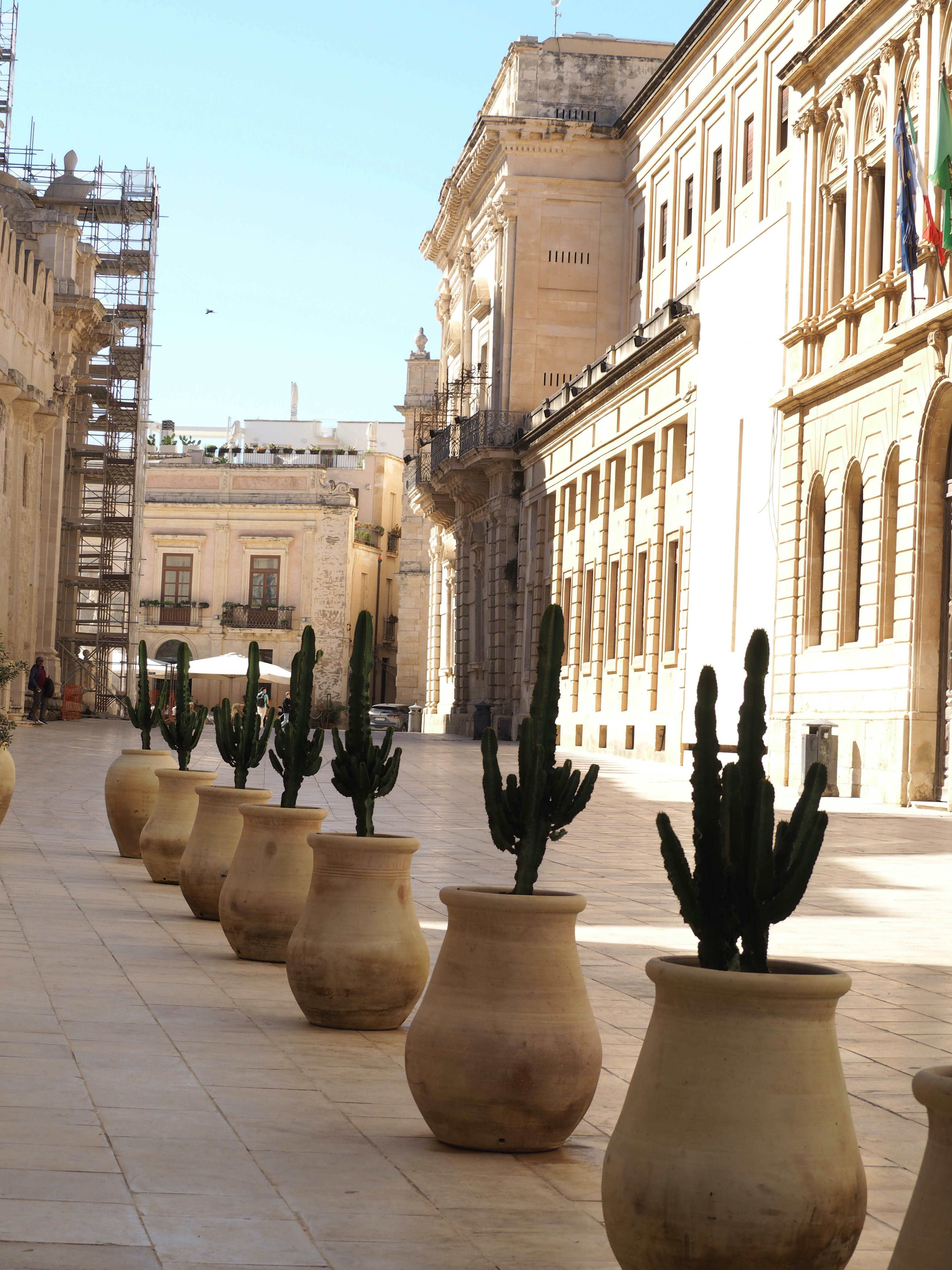 Terracotta Pots Line the Sunlit Portico