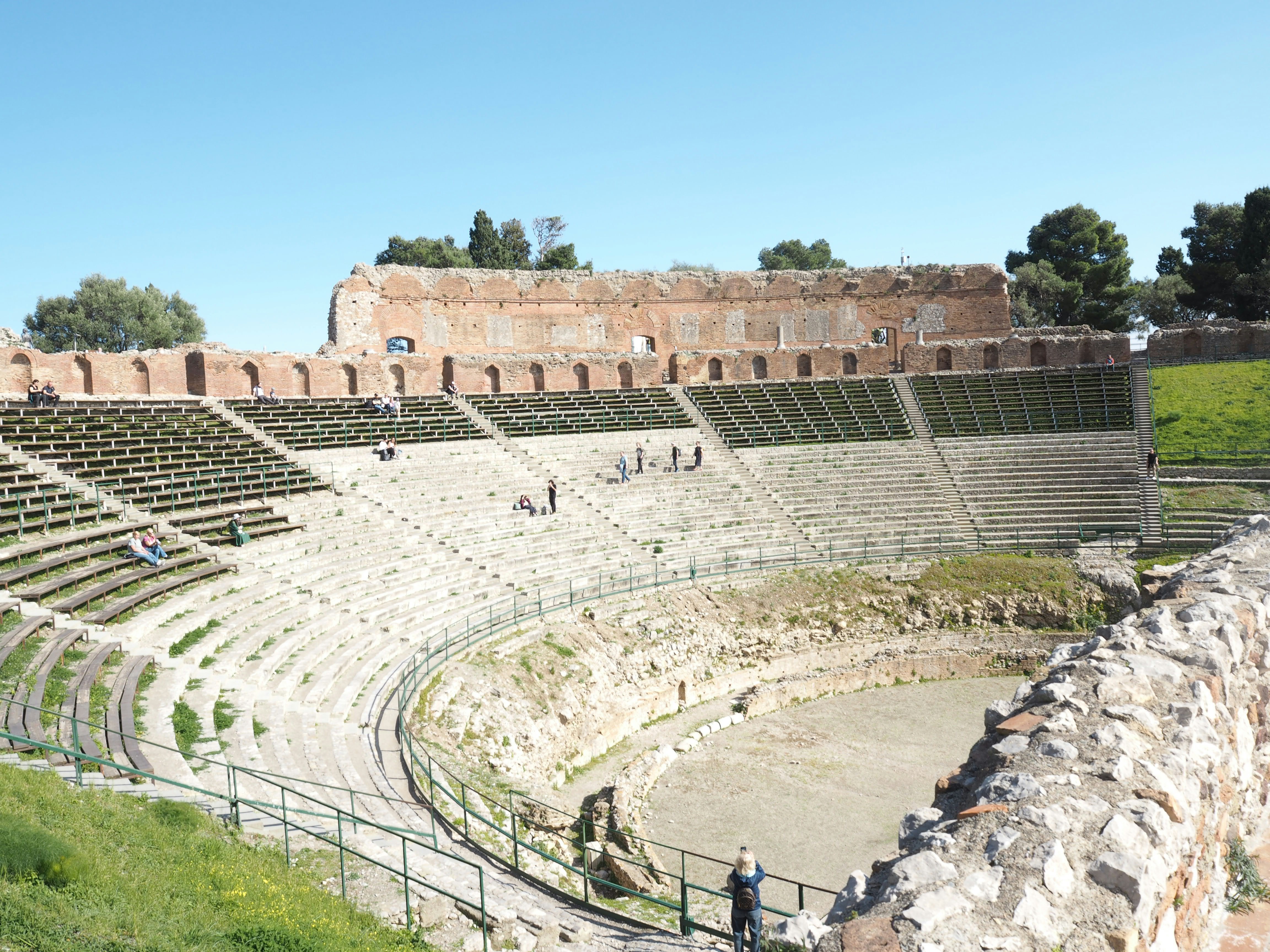 Whispers of Stone: An Ancient Roman Arena Embraced by Sunlit Terrace