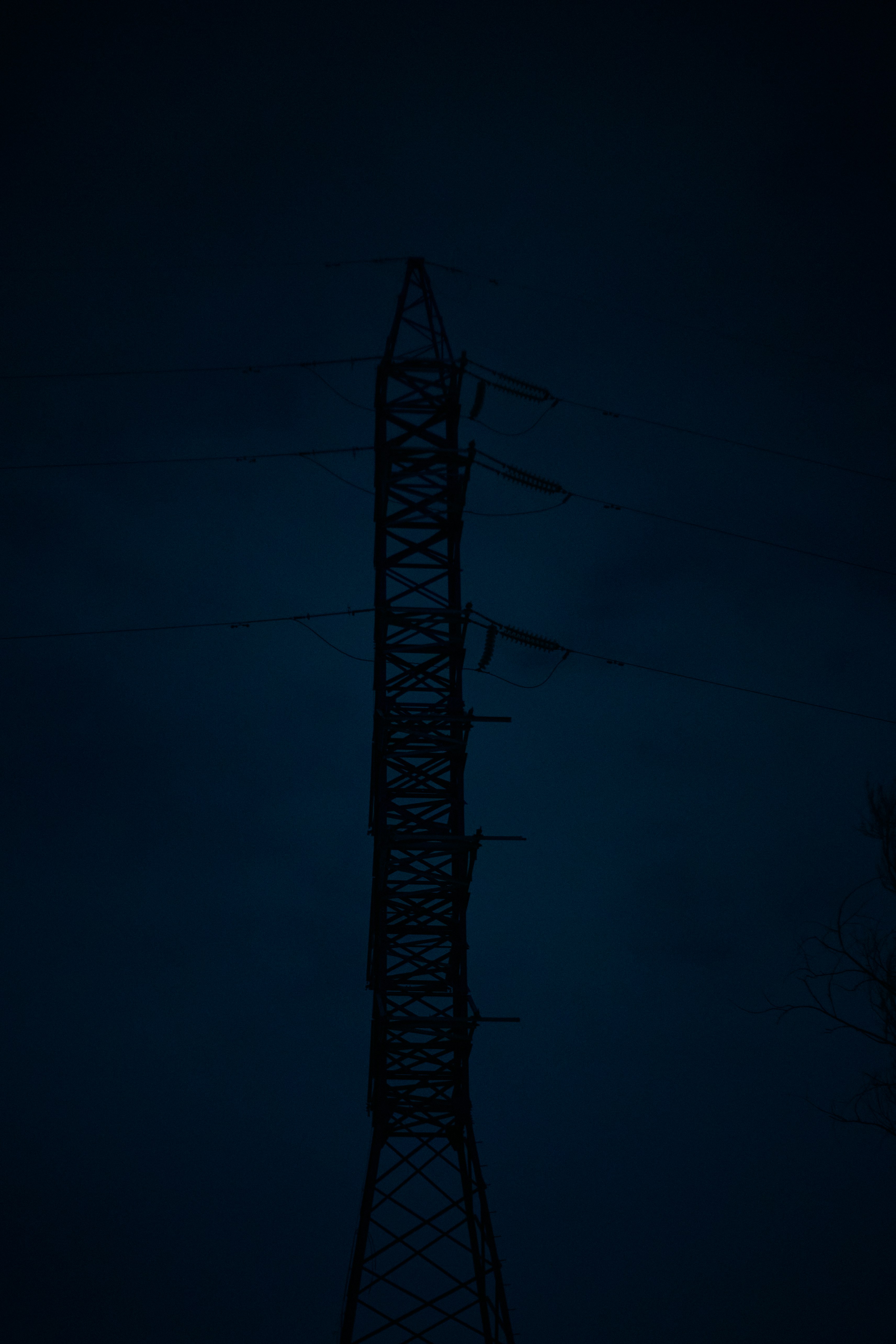 Night Pulse: A Lone Transmission Tower Stands Against a Velvet Sky