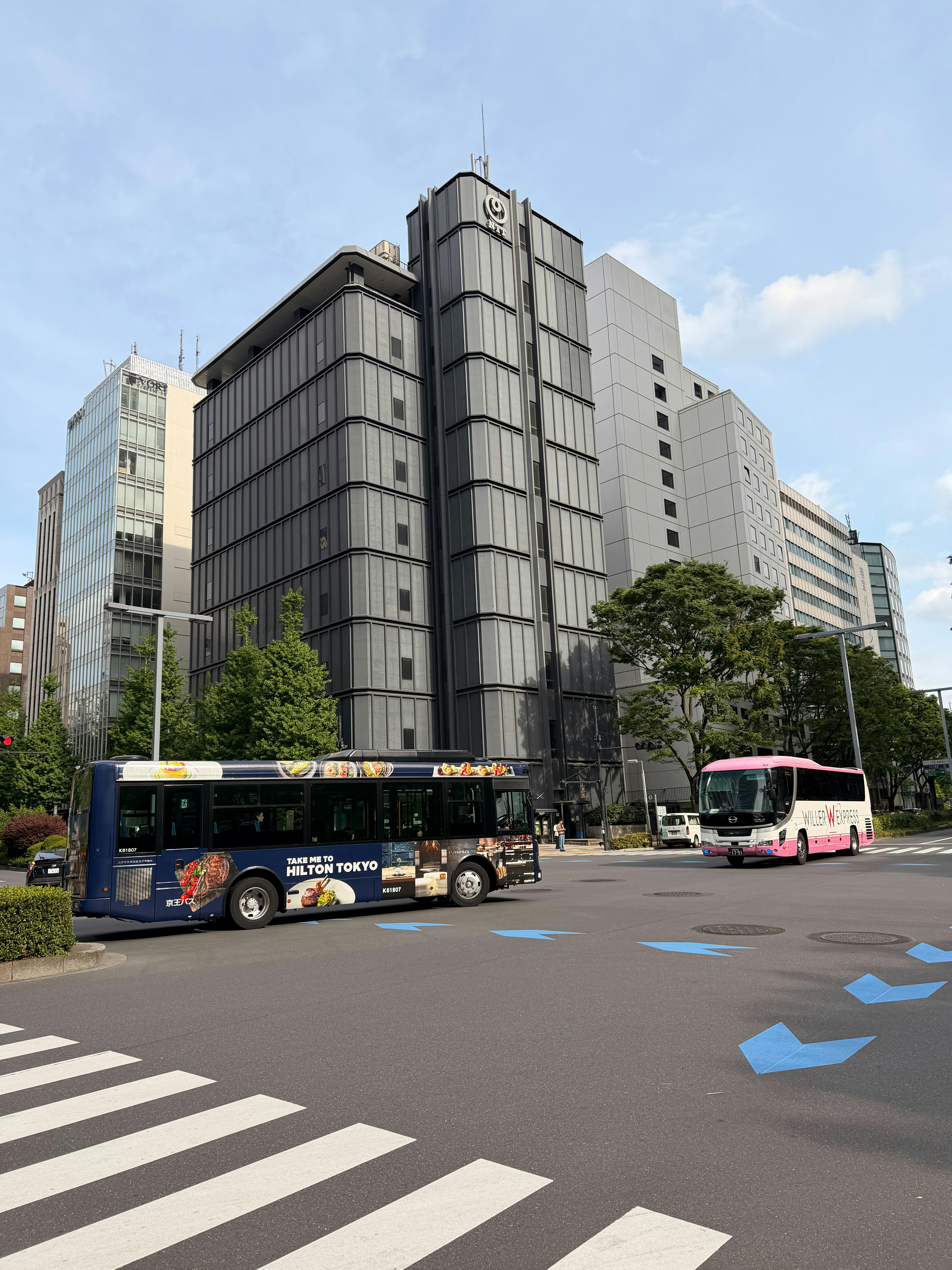 Towering Junction: Buses at a Modern City Crossing