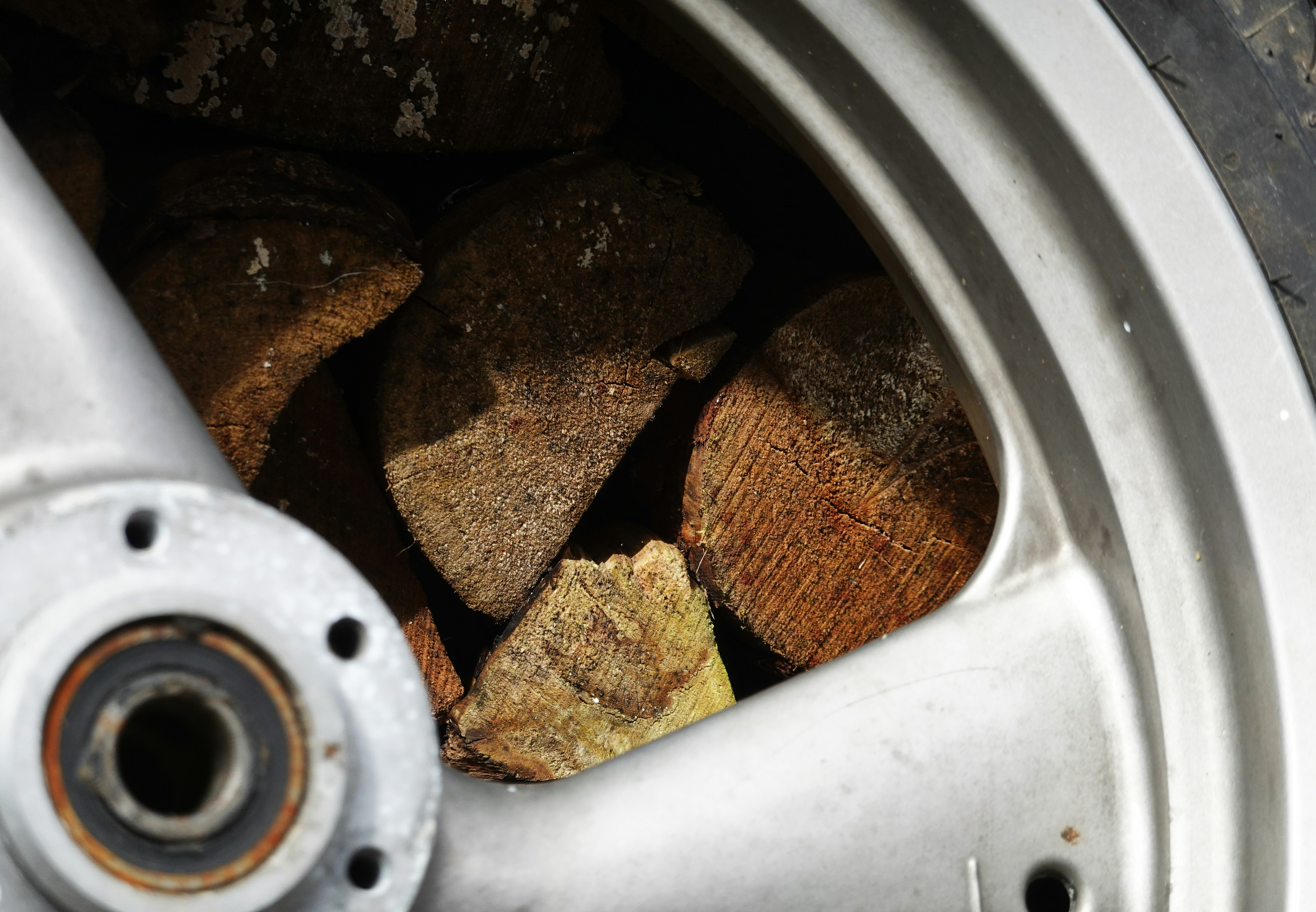 Weighed Wood: Stacked Logs in a Spoked Wheel
