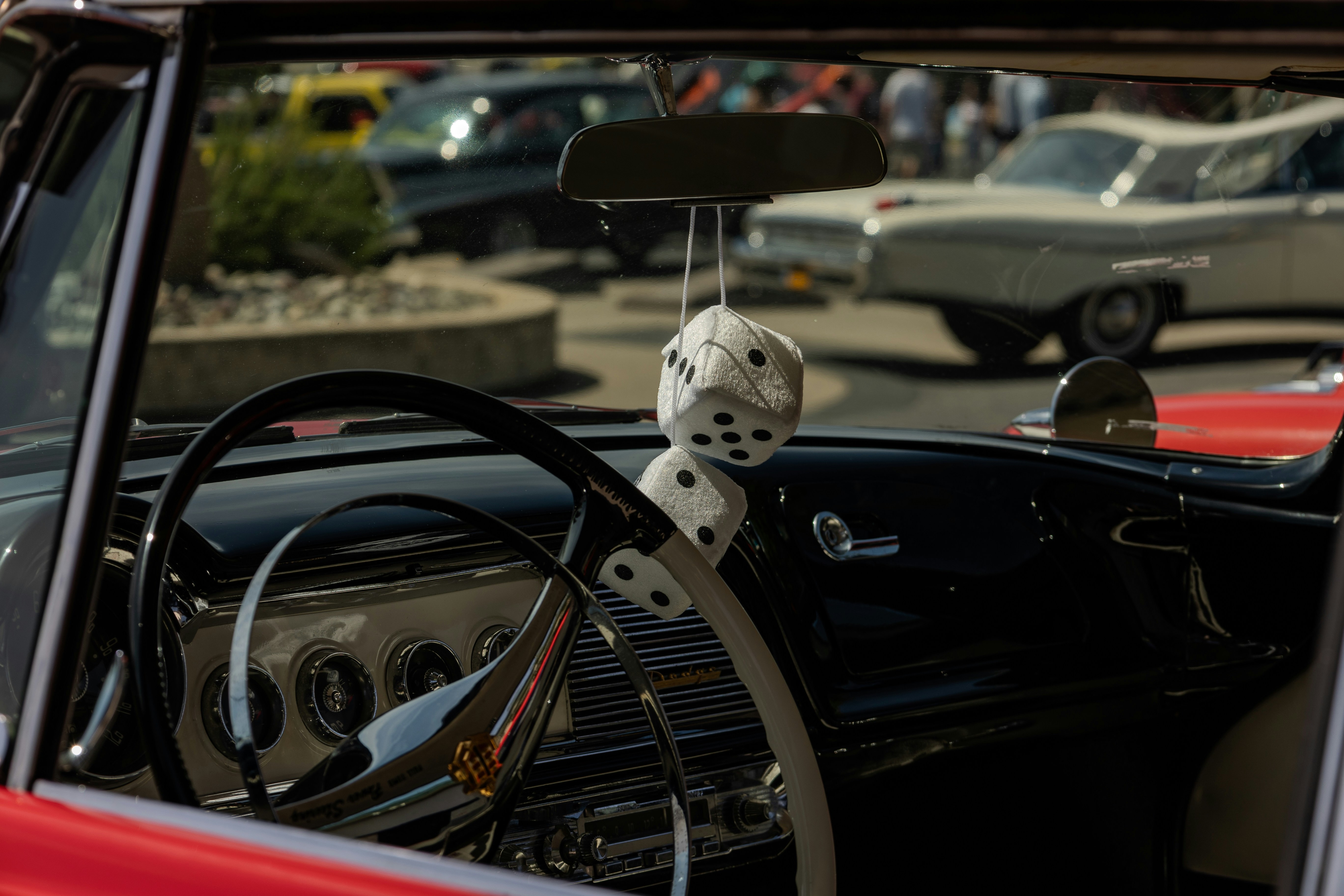 Rearview of a nostalgic showroom: Dangled dice and classic dashboard