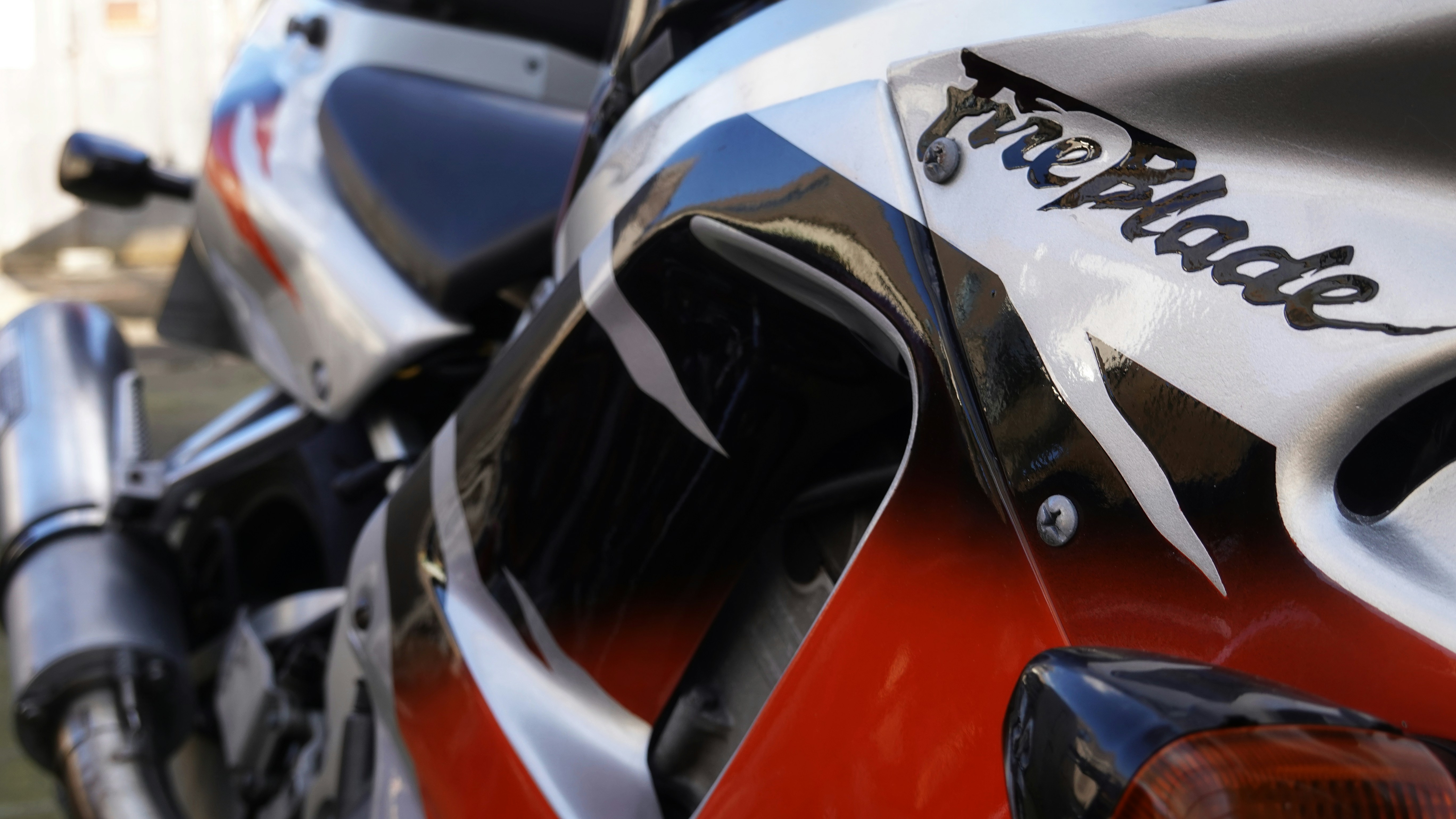 Racing chrome: a close-up of a sport motorcycle's side with bold graphics