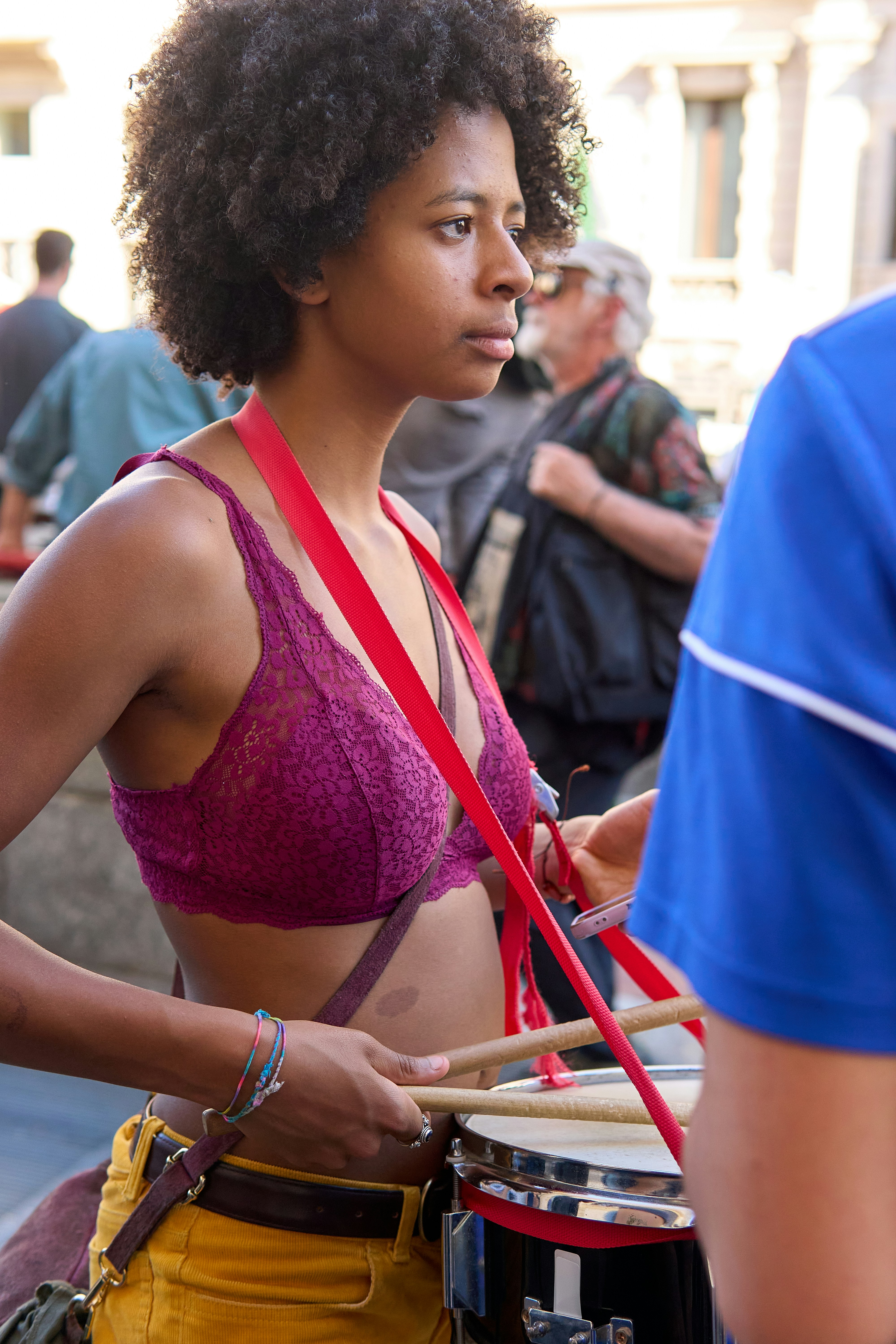 Drummer in Lace: A Focused Portrait at Street Level