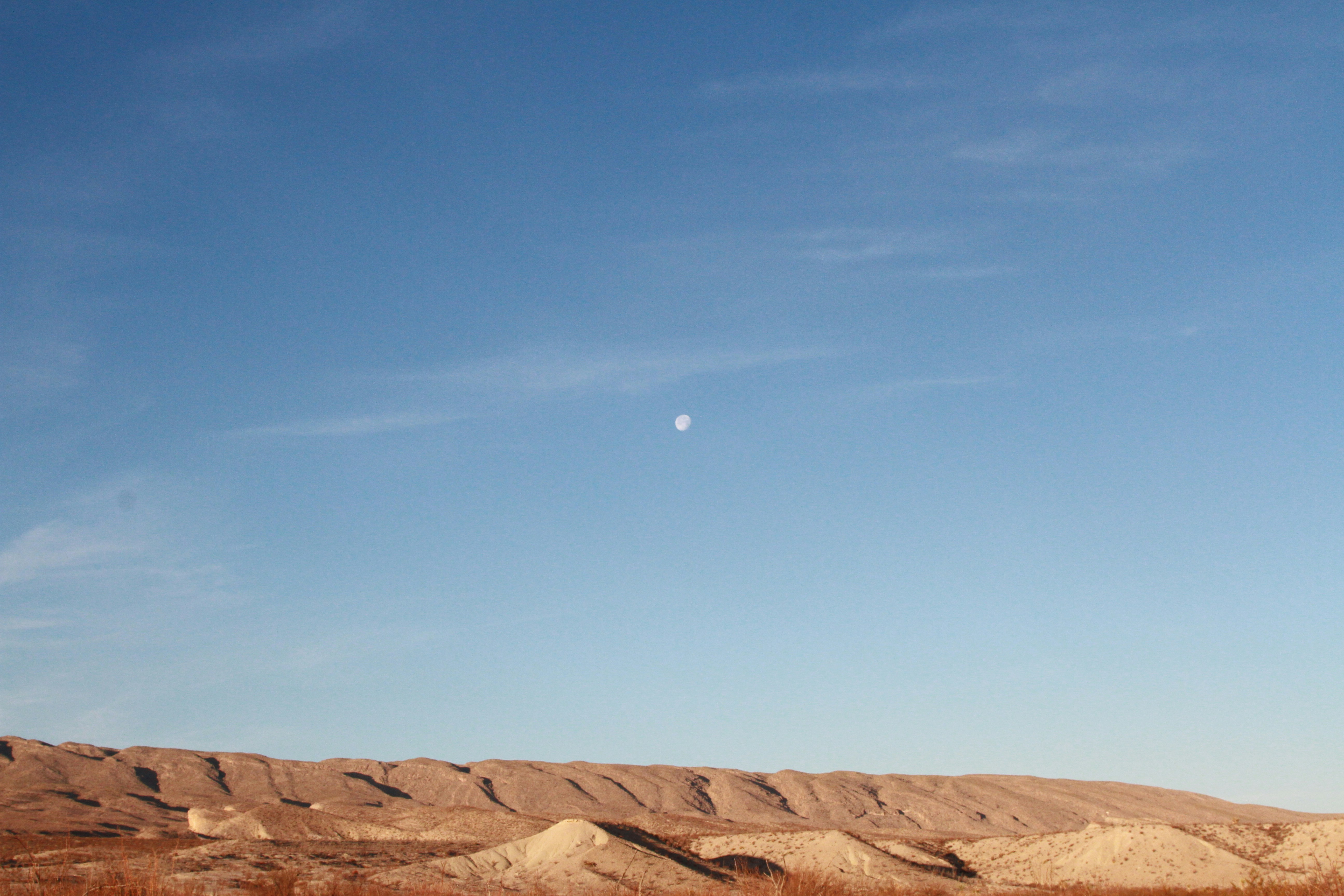  Desert Horizon: Moon over Weathered Ridges
