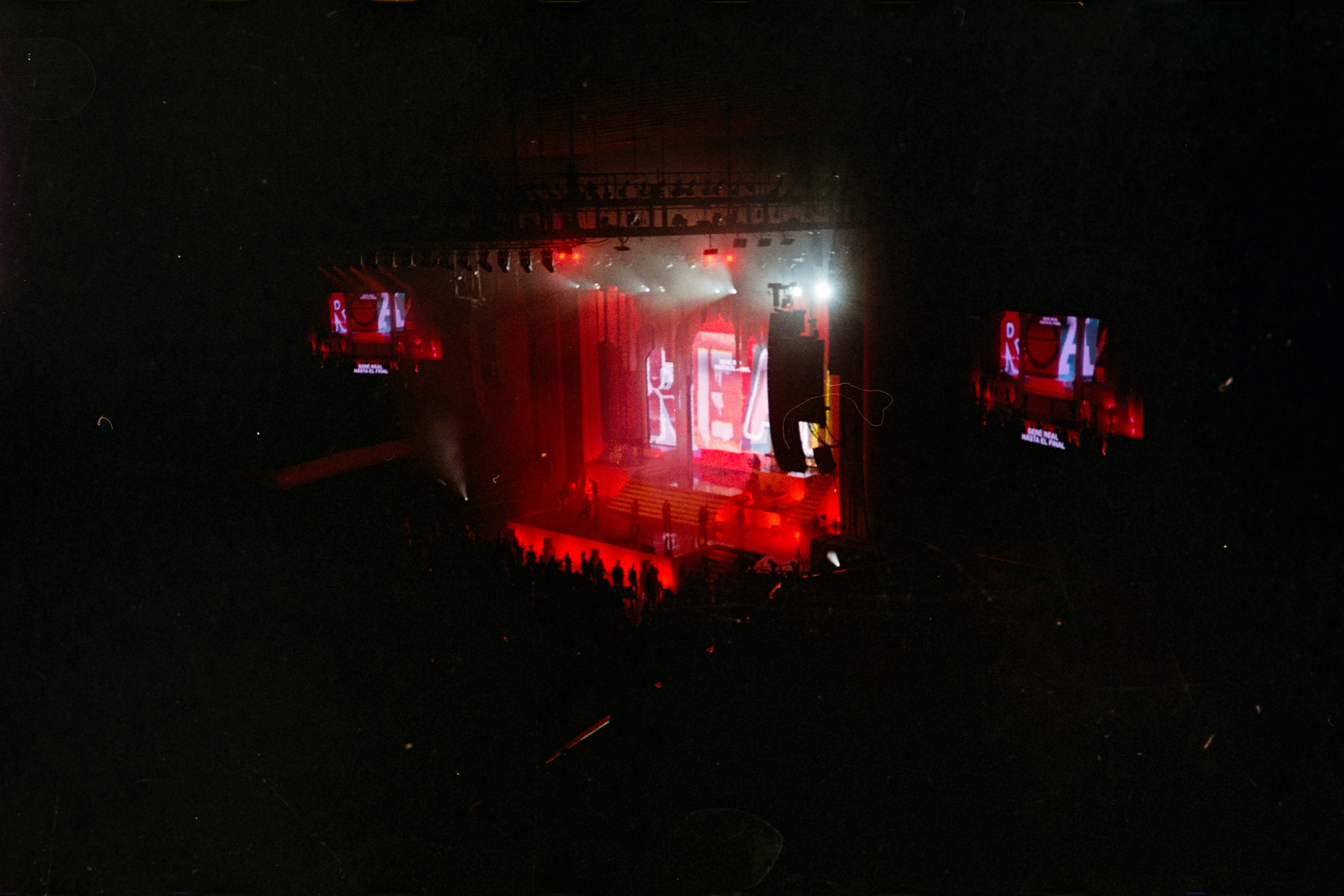 Stage Light Echoes: A Red-Hued Concert in the Dark