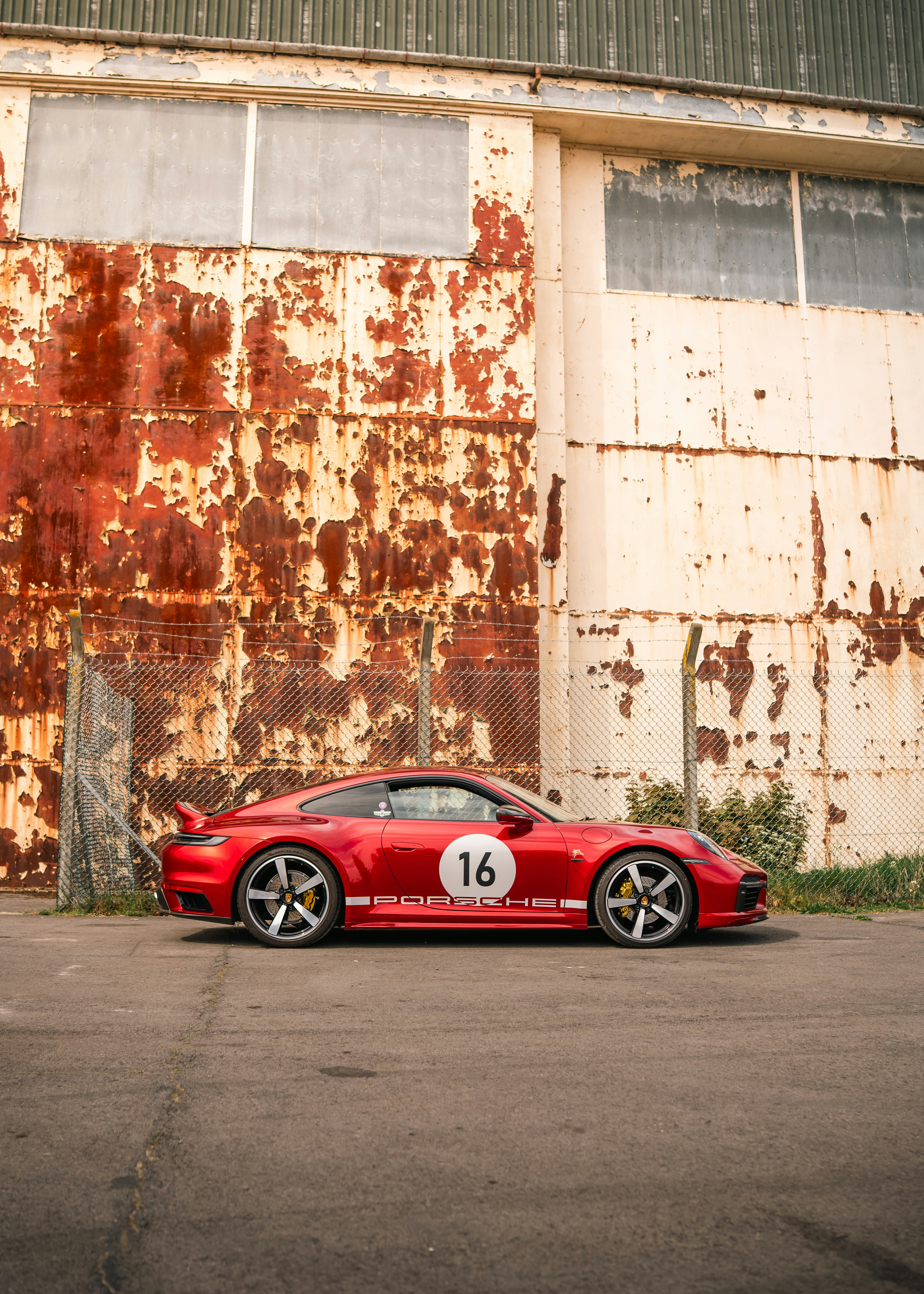 Red Porsche at the Edge: A Steel-Cooled Car in a Weathered Yard
